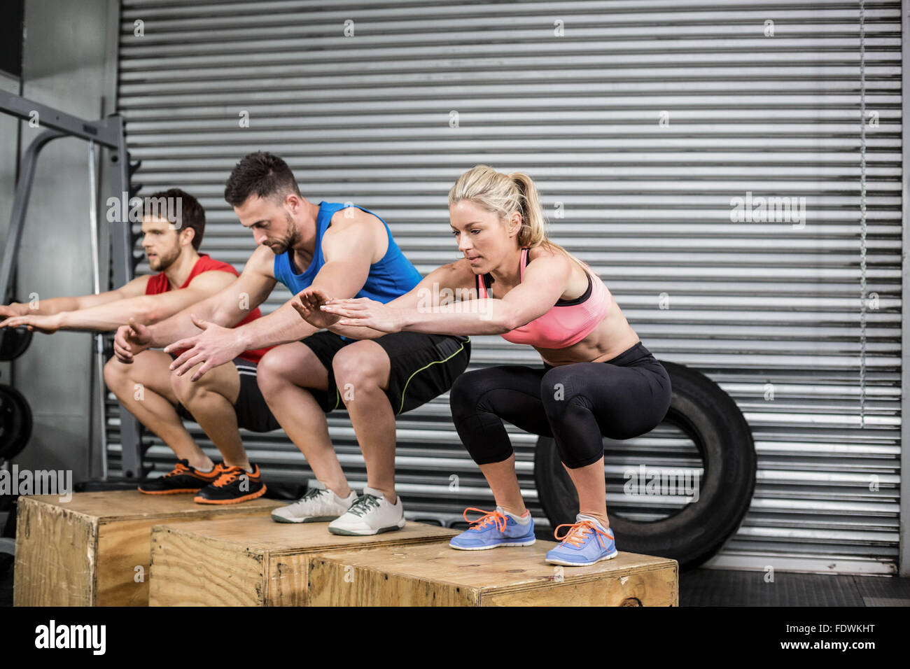 Fit people doing exercises with box Stock Photo - Alamy