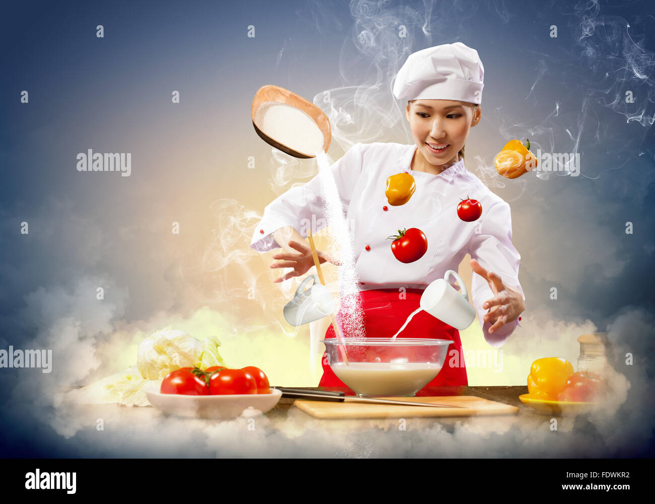 Asian female cooking with magic against color background Stock Photo ...