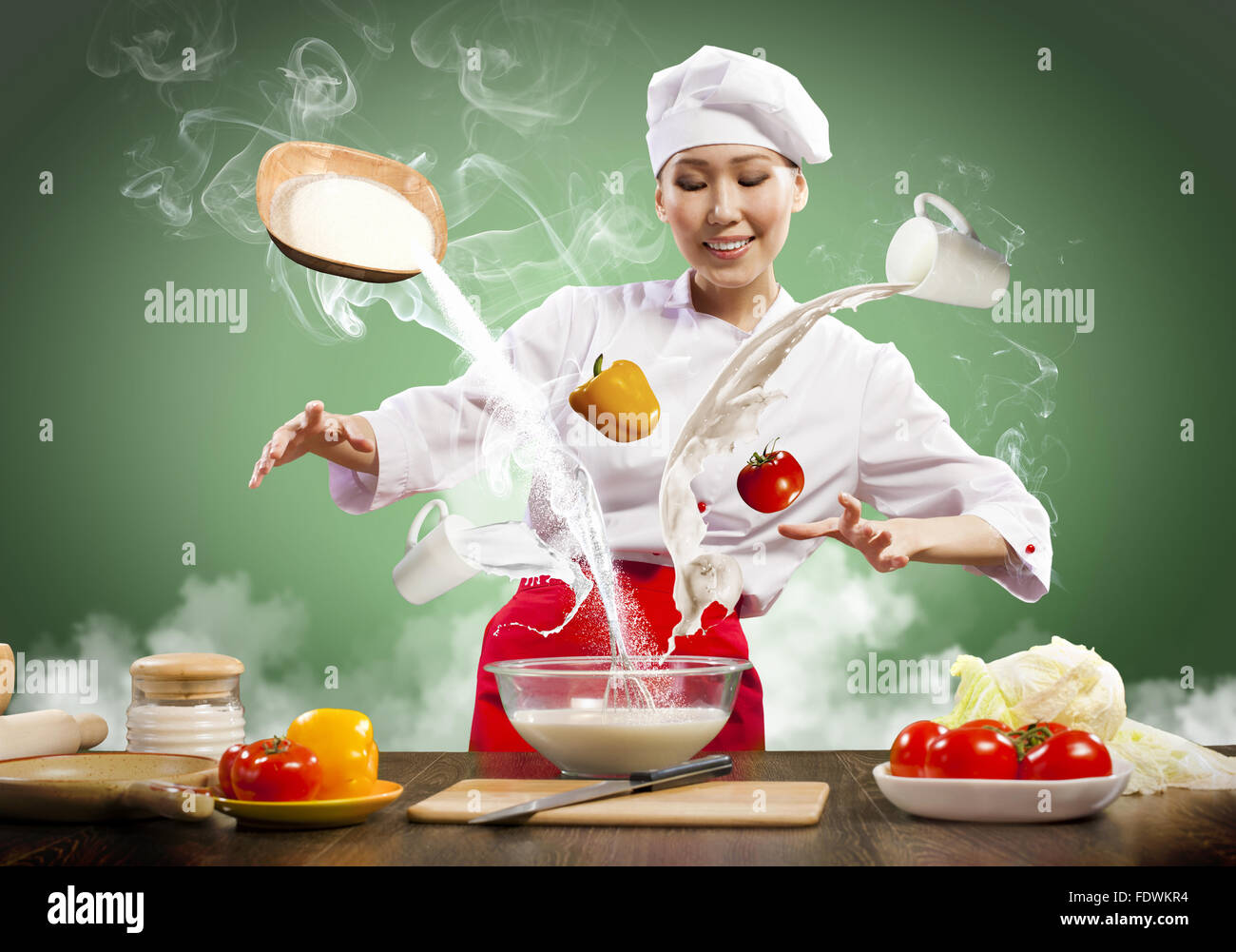 Asian female cooking with magic against color background Stock Photo ...