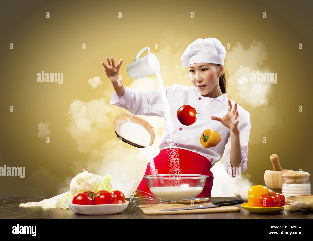 Asian female cooking with magic against color background Stock Photo ...