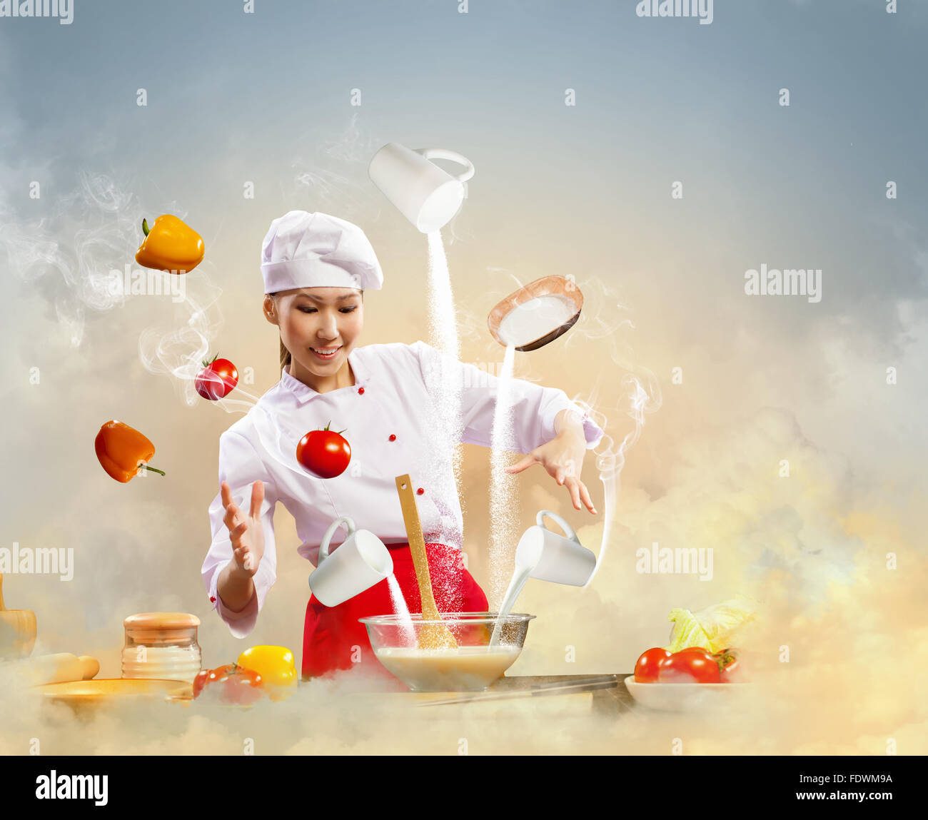 Asian female cooking with magic against color background Stock Photo ...
