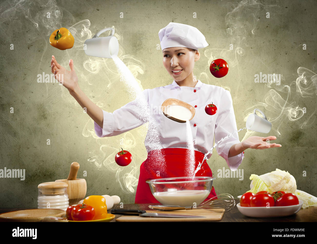 Asian female cooking with magic against color background Stock Photo ...