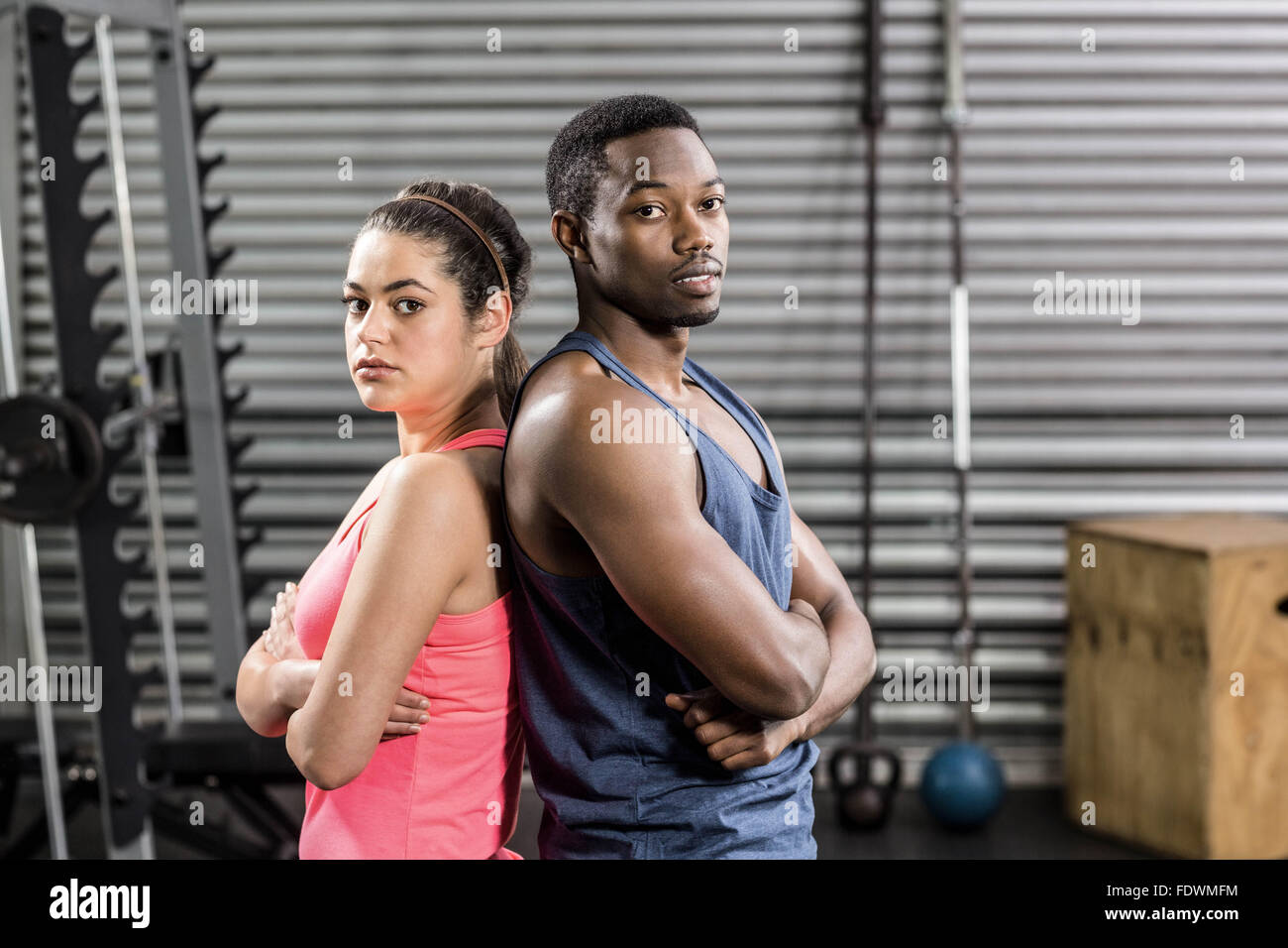 Fit couple back to back Stock Photo - Alamy