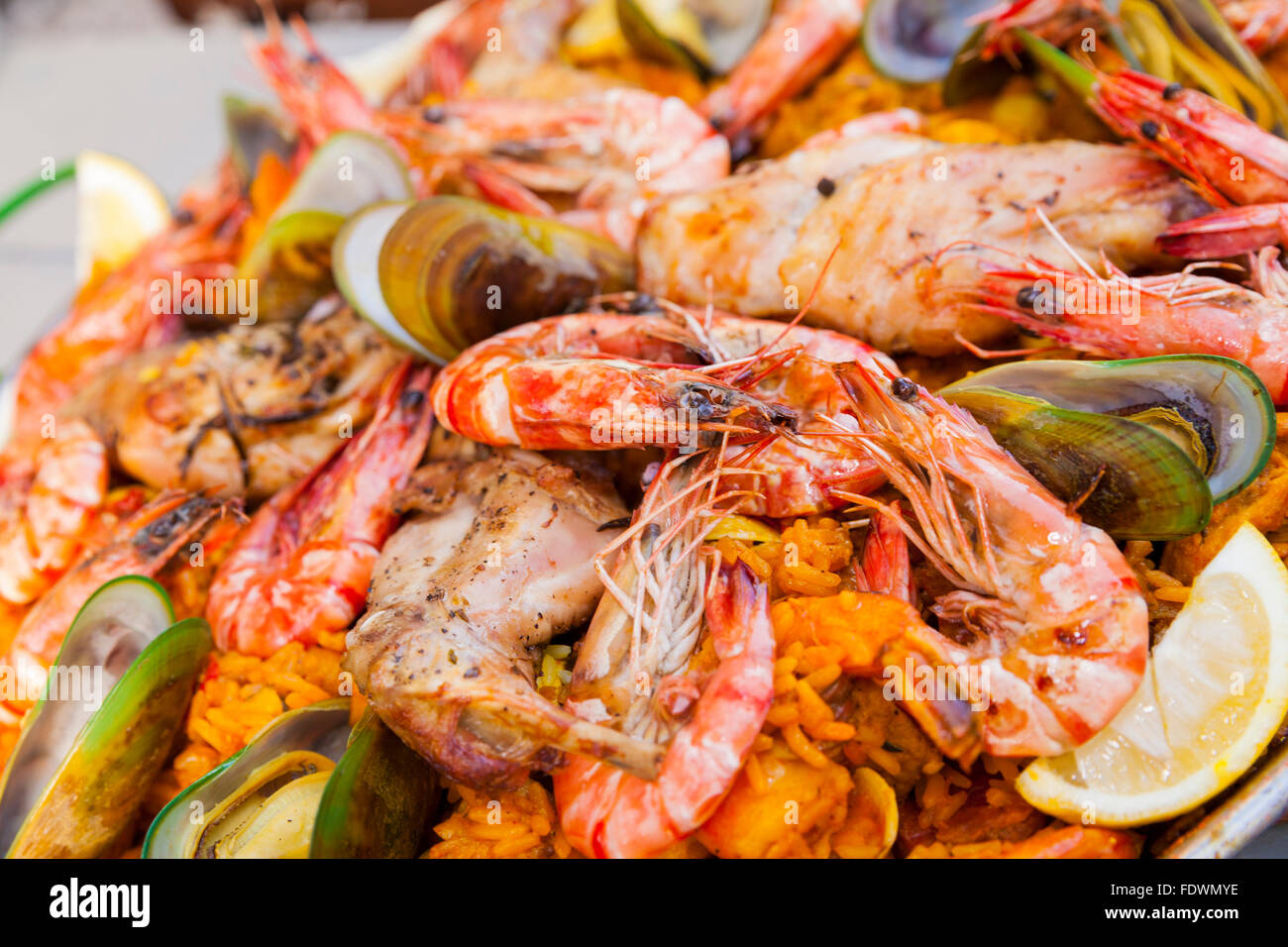 spanish seafood paella traditional rice dish in huge pan in summer ...