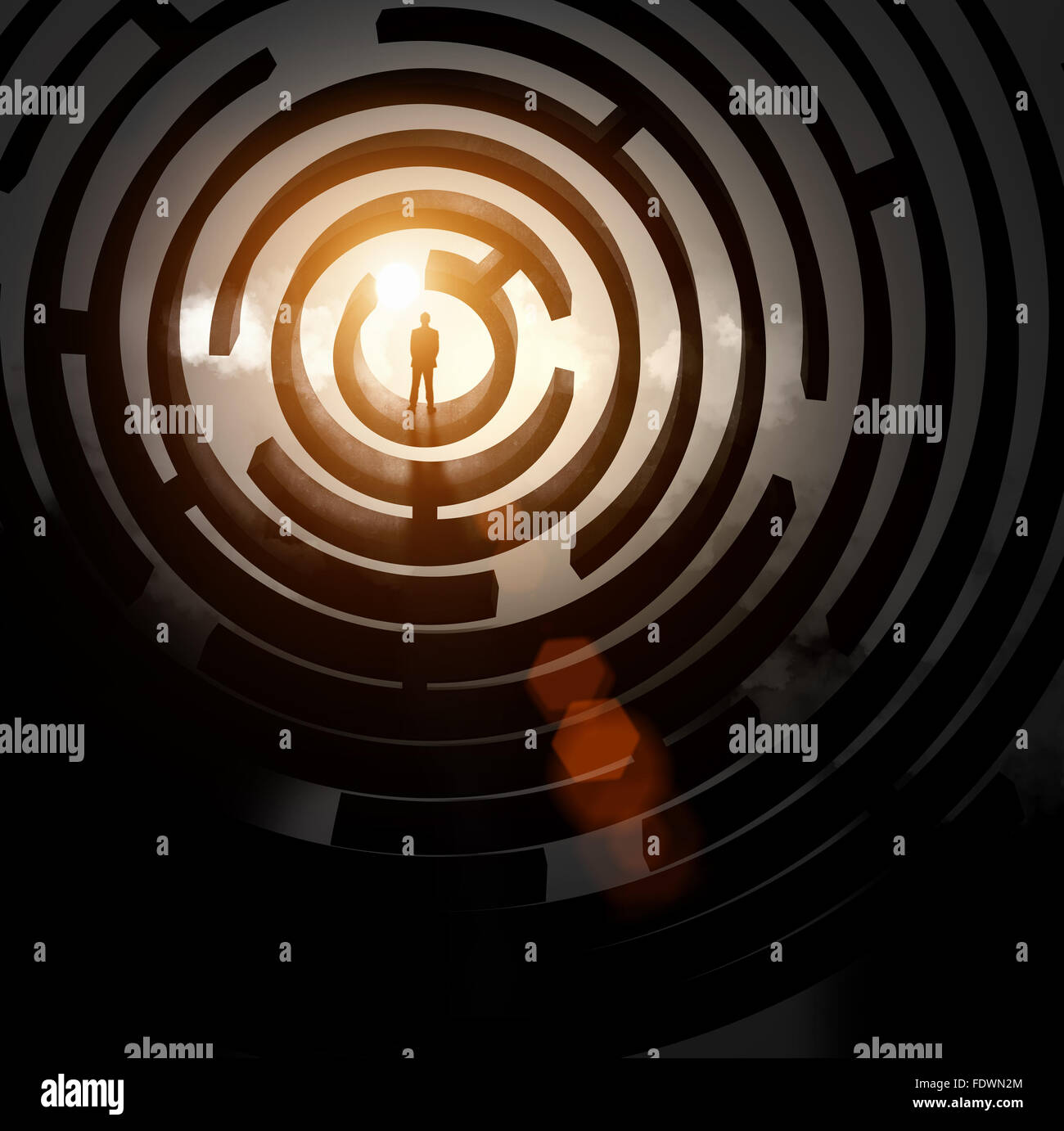Silhouette of businessman standing in maze sun above Stock Photo - Alamy