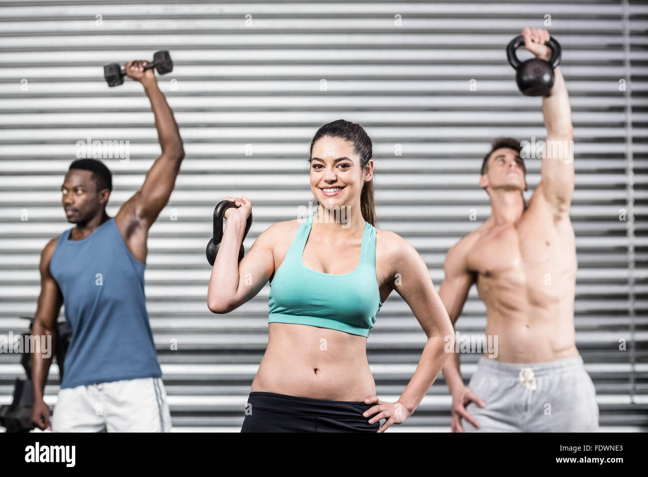 Fit people lifting dumbbells Stock Photo - Alamy