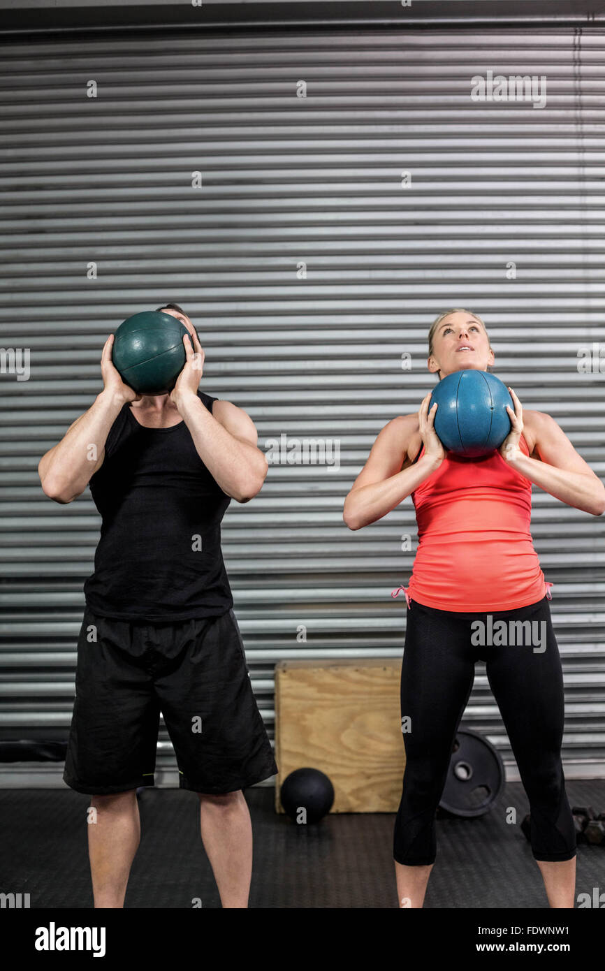 Couple throwing ball in the air Stock Photo - Alamy