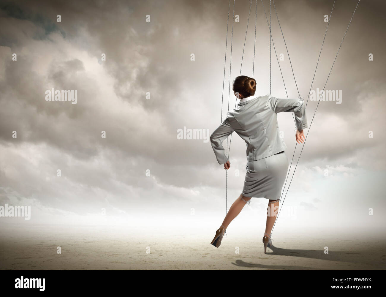 Image of businesswoman hanging on strings like marionette. Conceptual ...