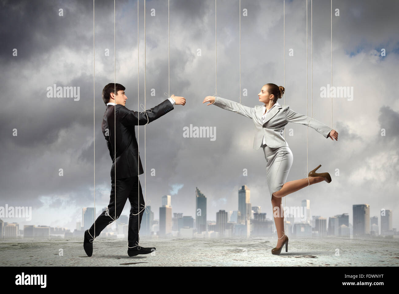Image of businesspeople hanging on strings like marionettes against ...