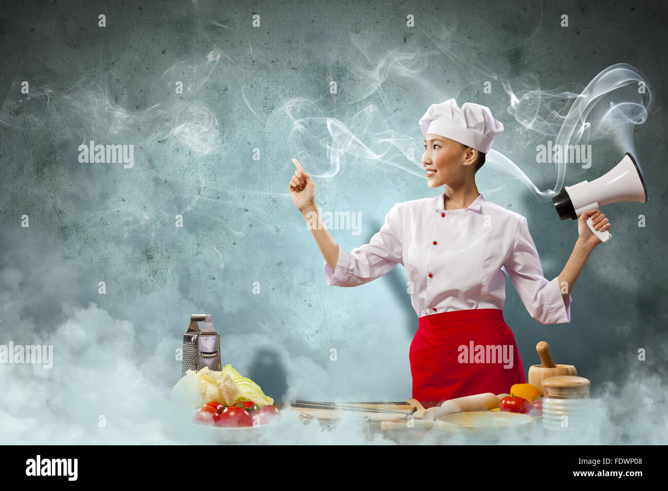 Asian female young cook smiling holding megaphone Stock Photo - Alamy
