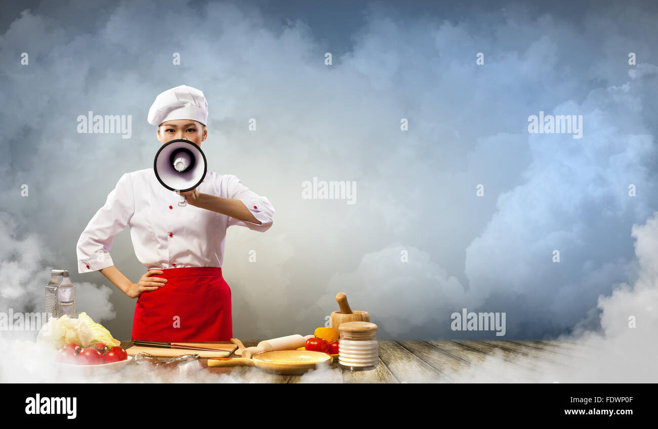 Asian female cook screaming loud in megaphone Stock Photo - Alamy