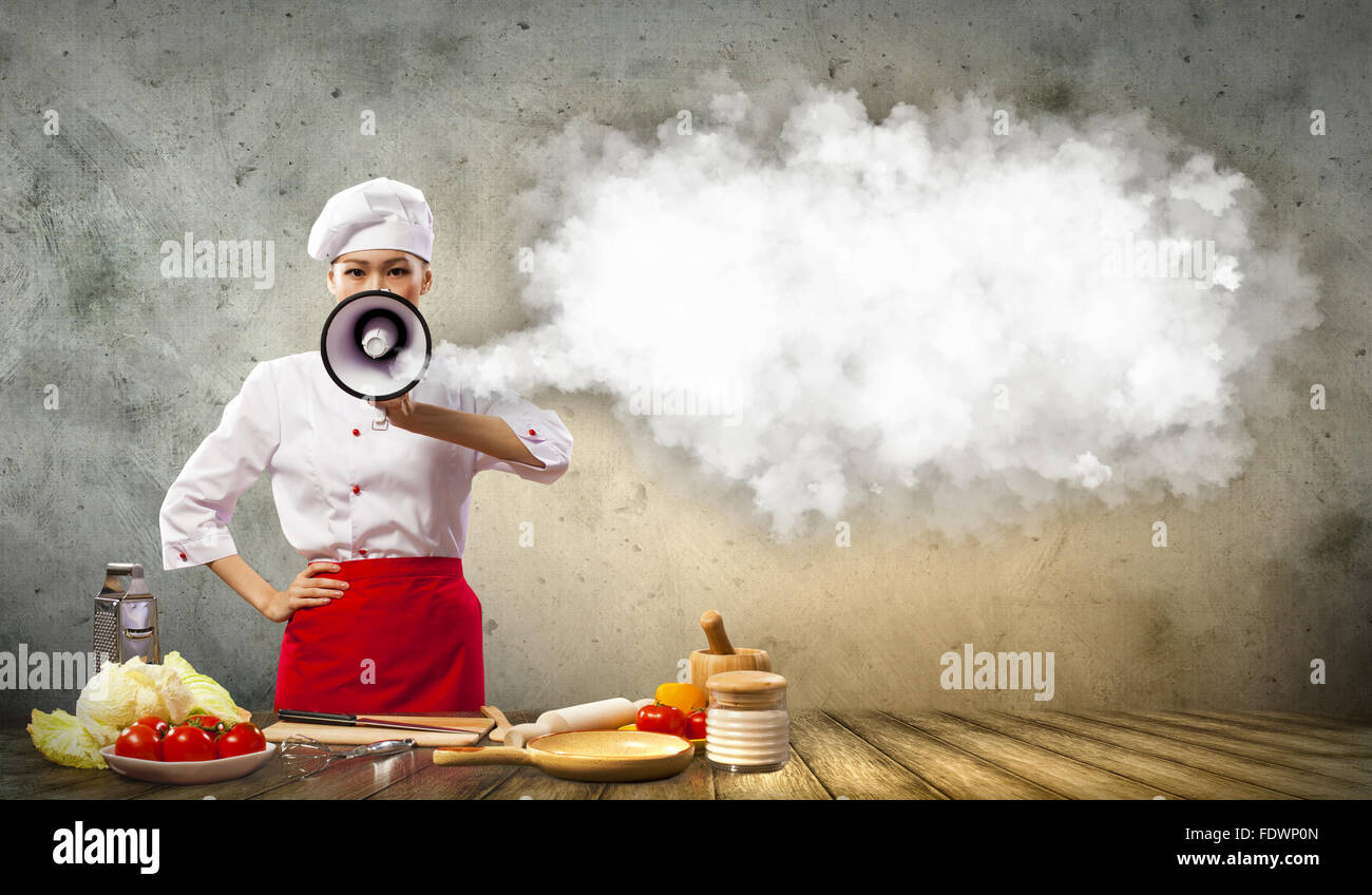 Asian female cook screaming loud in megaphone Stock Photo - Alamy