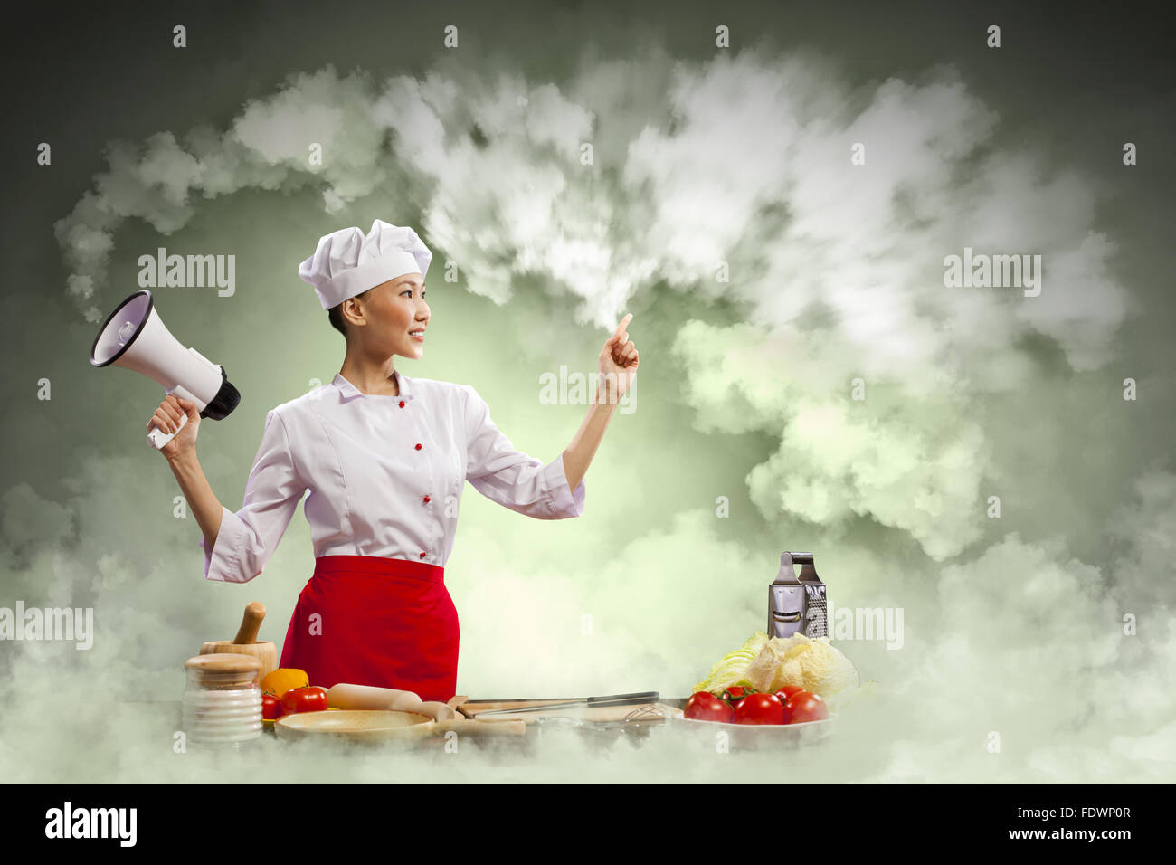 Asian female young cook smiling holding megaphone Stock Photo - Alamy