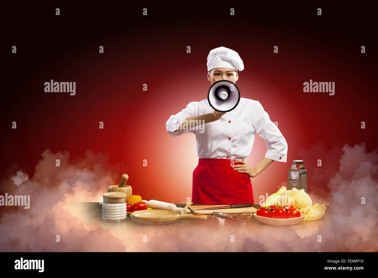 Asian female cook screaming loud in megaphone Stock Photo - Alamy