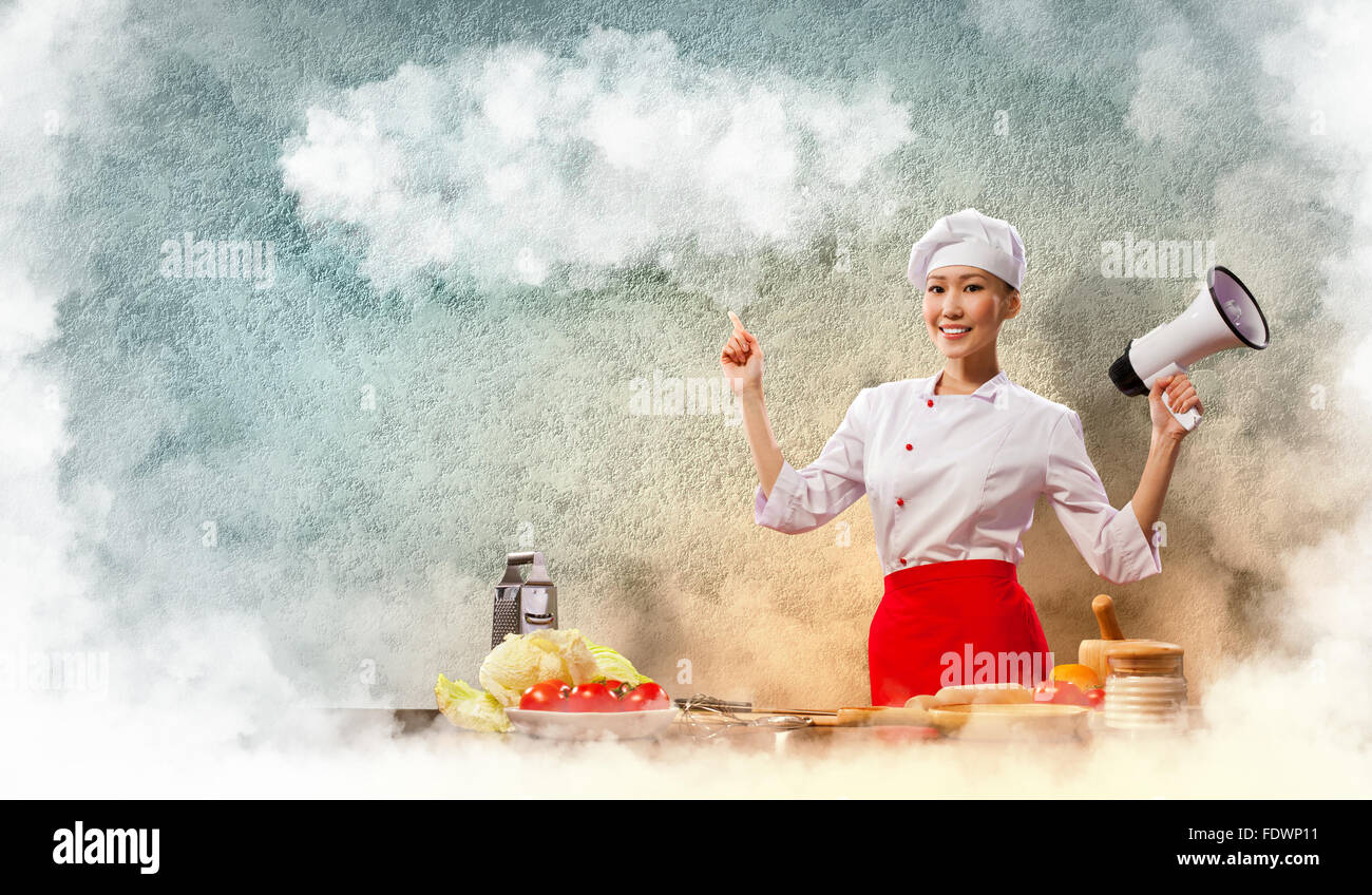 Asian female cook holding megaphone with space for text Stock Photo - Alamy