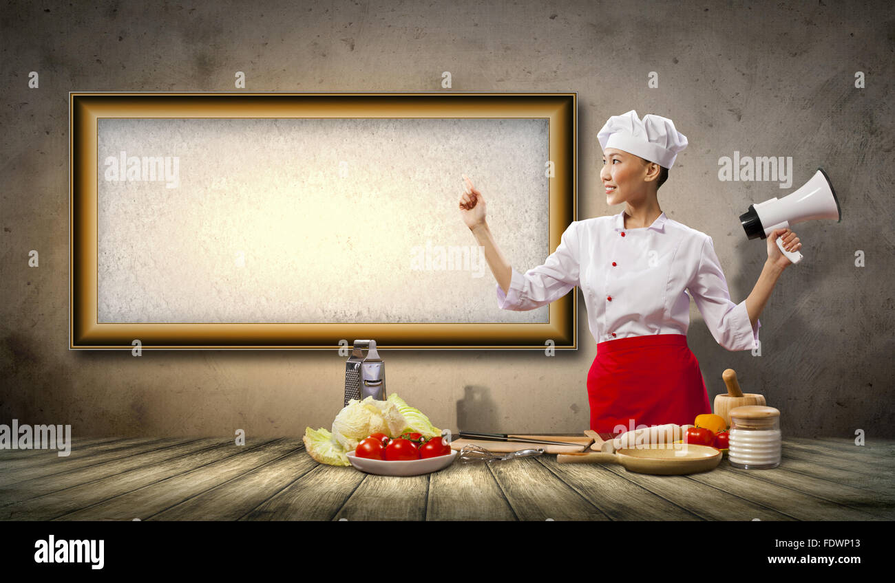 Asian female cook holding megaphone with space for text Stock Photo - Alamy