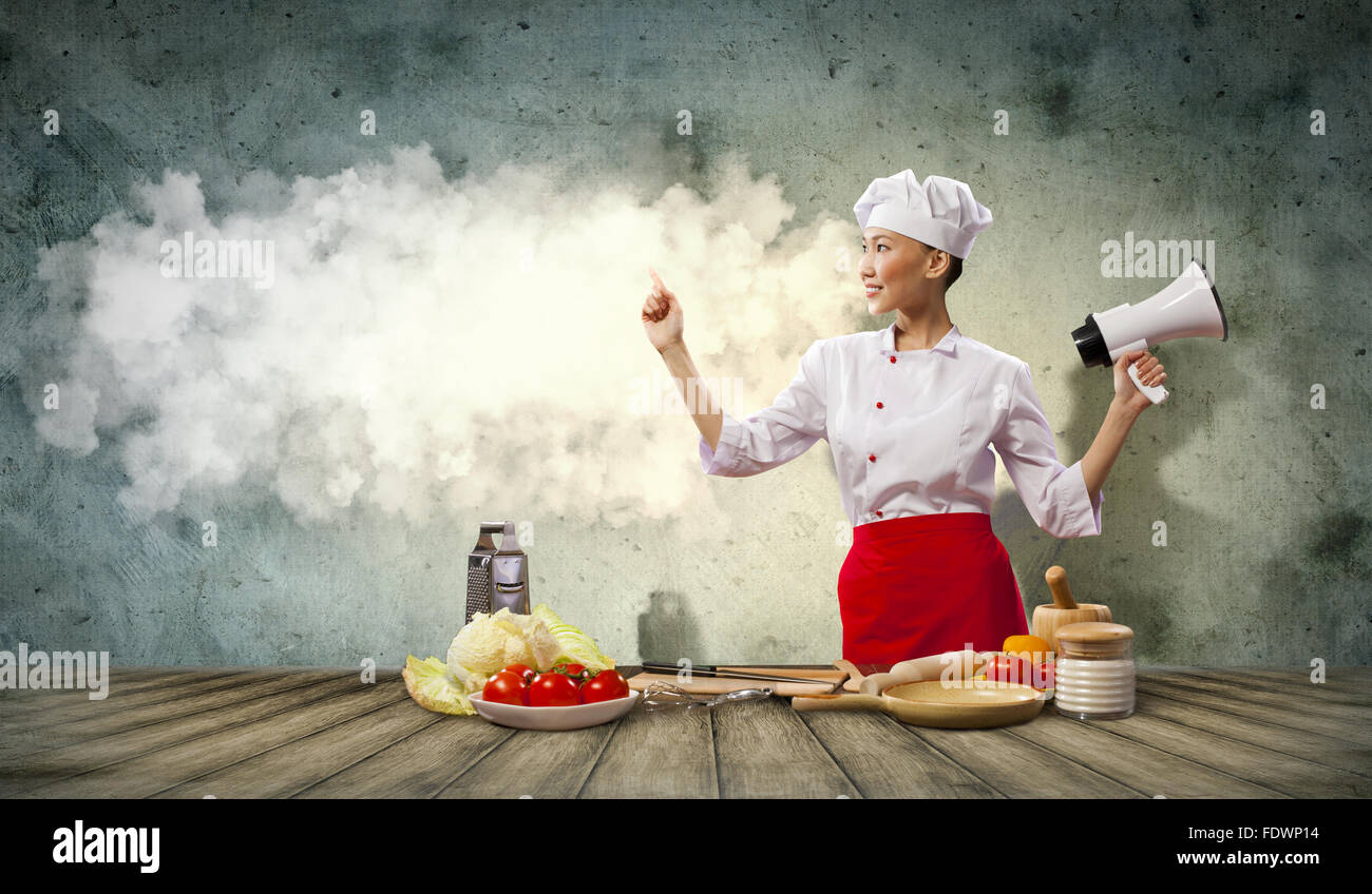 Asian female cook holding megaphone with space for text Stock Photo - Alamy