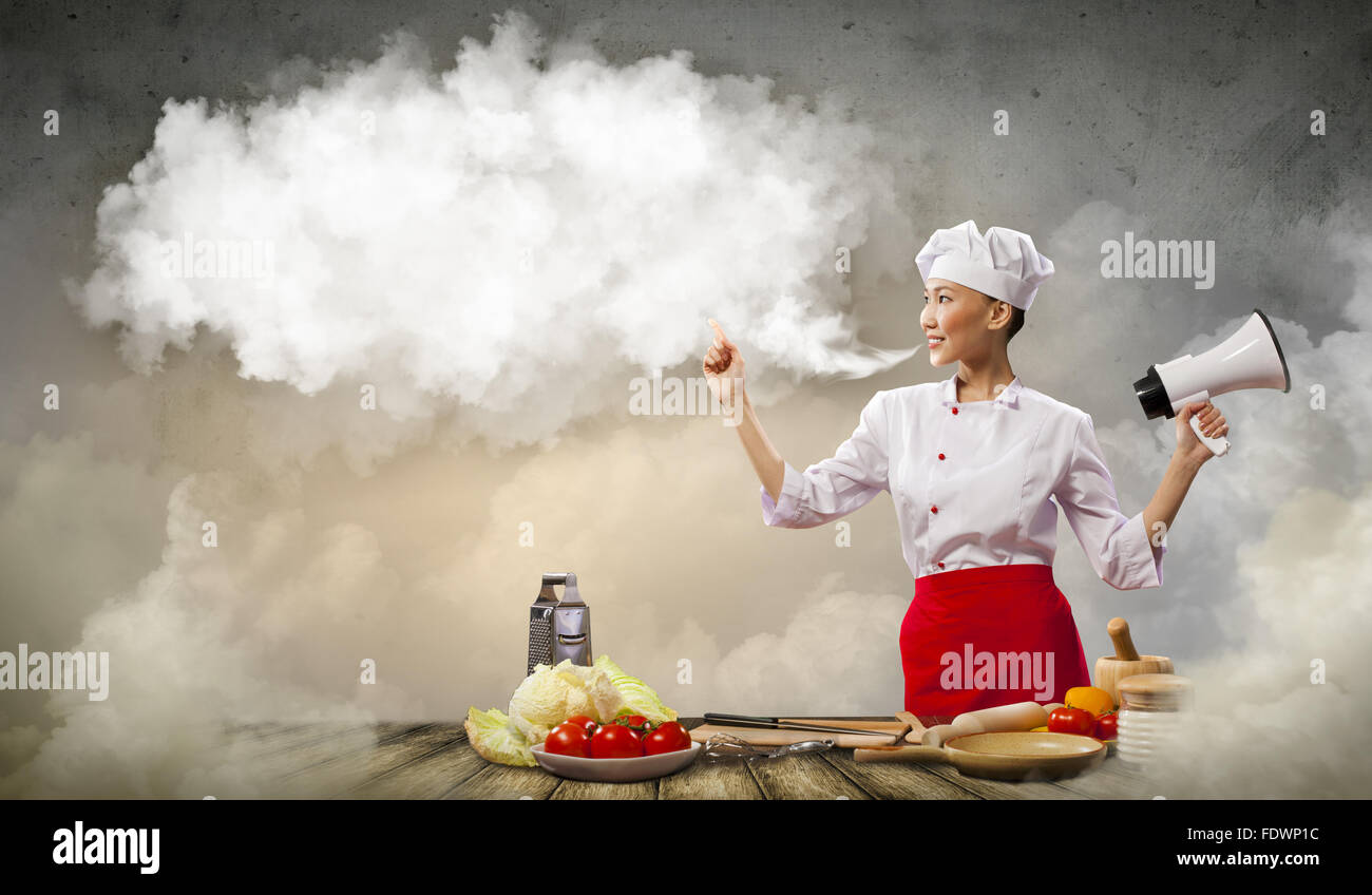 Asian female cook holding megaphone with space for text Stock Photo - Alamy