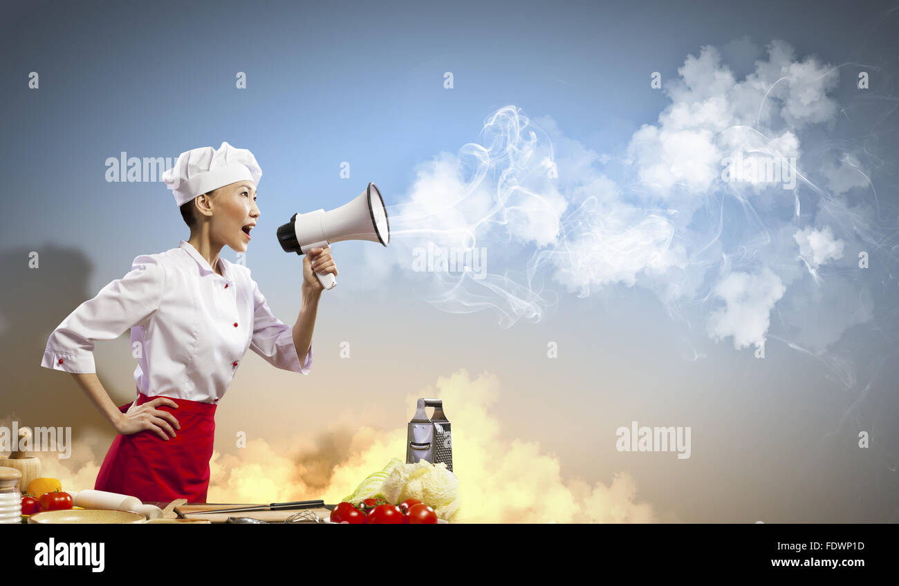 Asian female cook screaming loud in megaphone Stock Photo - Alamy