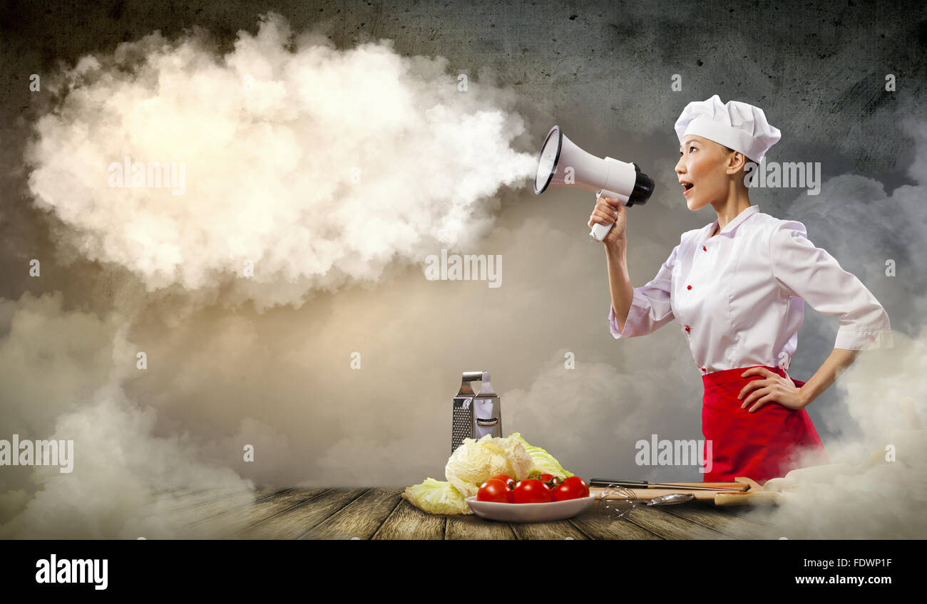 Asian female cook screaming loud in megaphone Stock Photo - Alamy