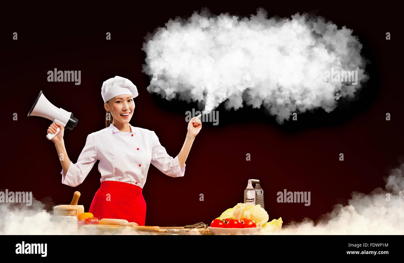 Asian female cook holding megaphone with space for text Stock Photo - Alamy
