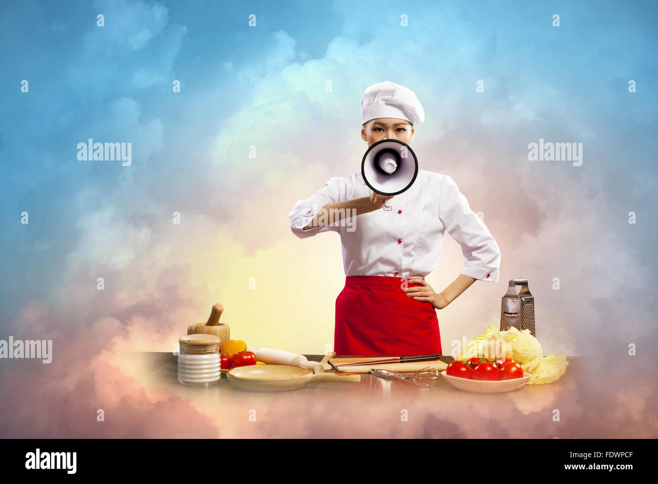 Asian female cook screaming loud in megaphone Stock Photo - Alamy