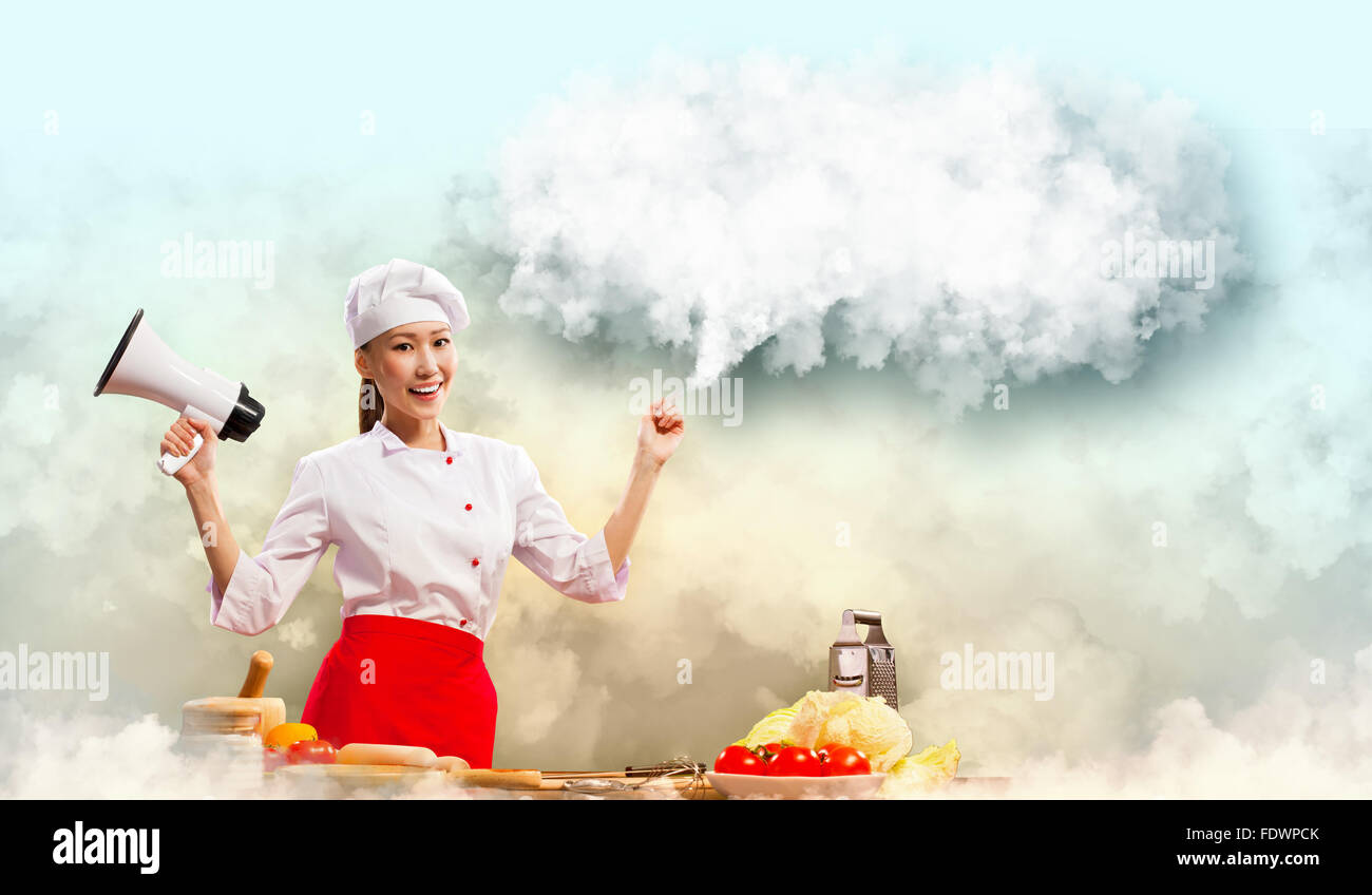 Asian female cook holding megaphone with space for text Stock Photo - Alamy
