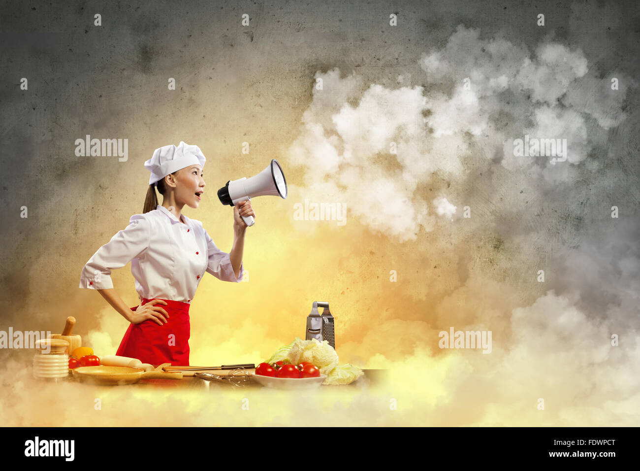 Asian female cook screaming loud in megaphone Stock Photo - Alamy