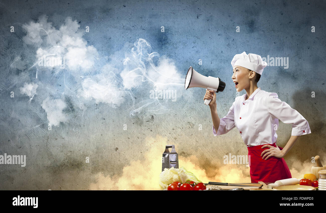 Asian female cook screaming loud in megaphone Stock Photo - Alamy