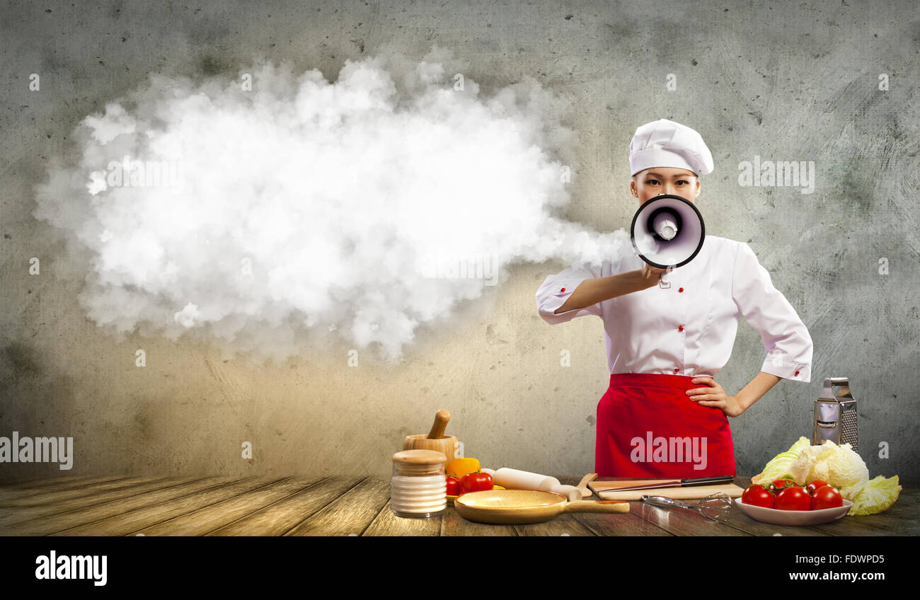 Asian female cook screaming loud in megaphone Stock Photo - Alamy