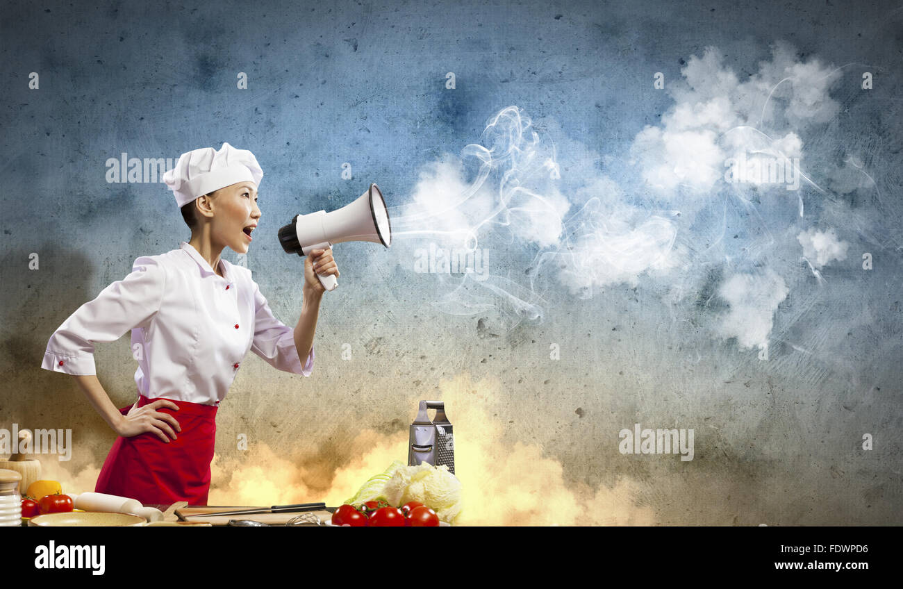 Asian female cook screaming loud in megaphone Stock Photo - Alamy