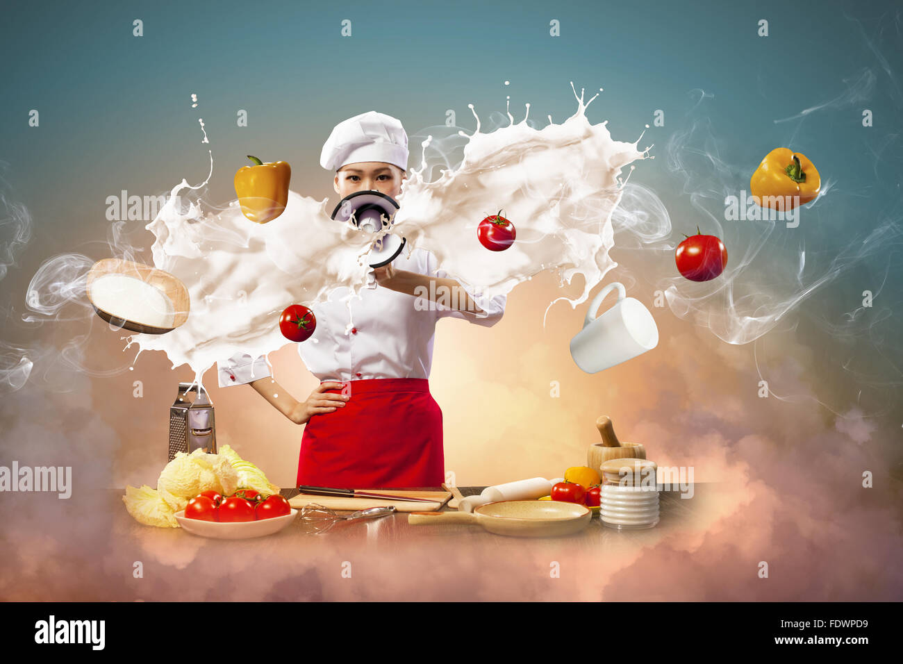 Asian female cook holding megaphone vegetables flying in air Stock ...