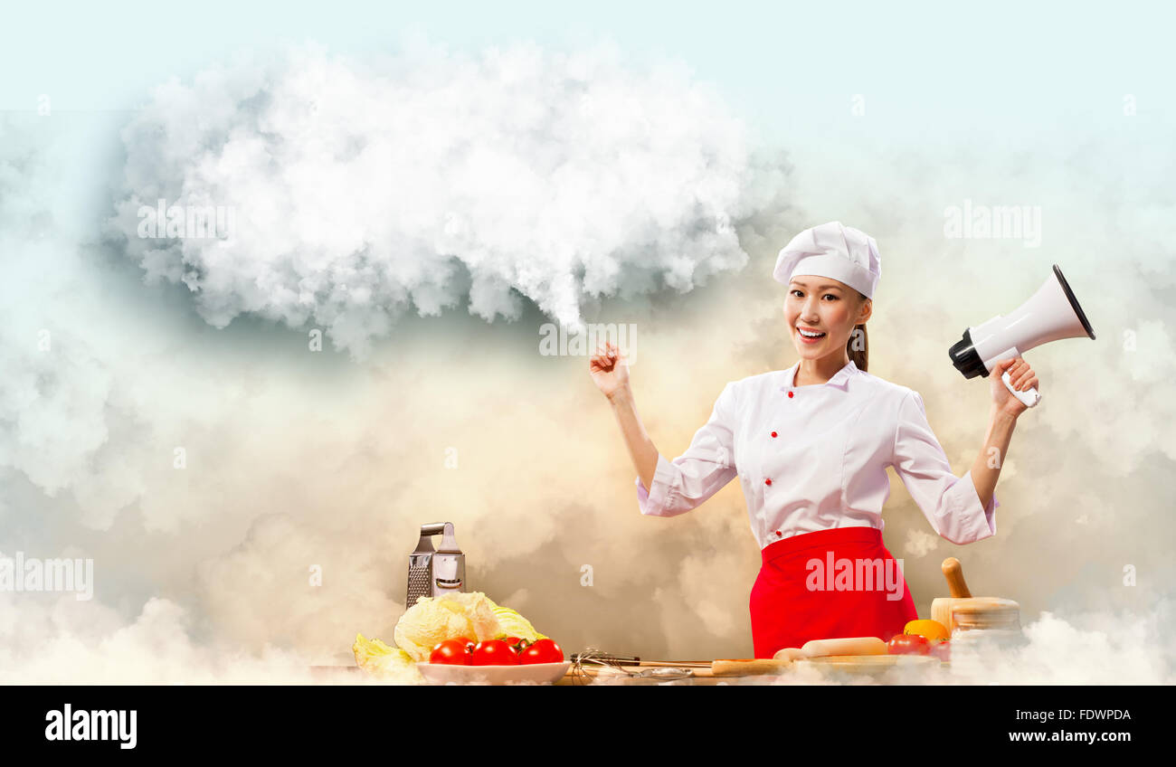 Asian female cook holding megaphone with space for text Stock Photo - Alamy