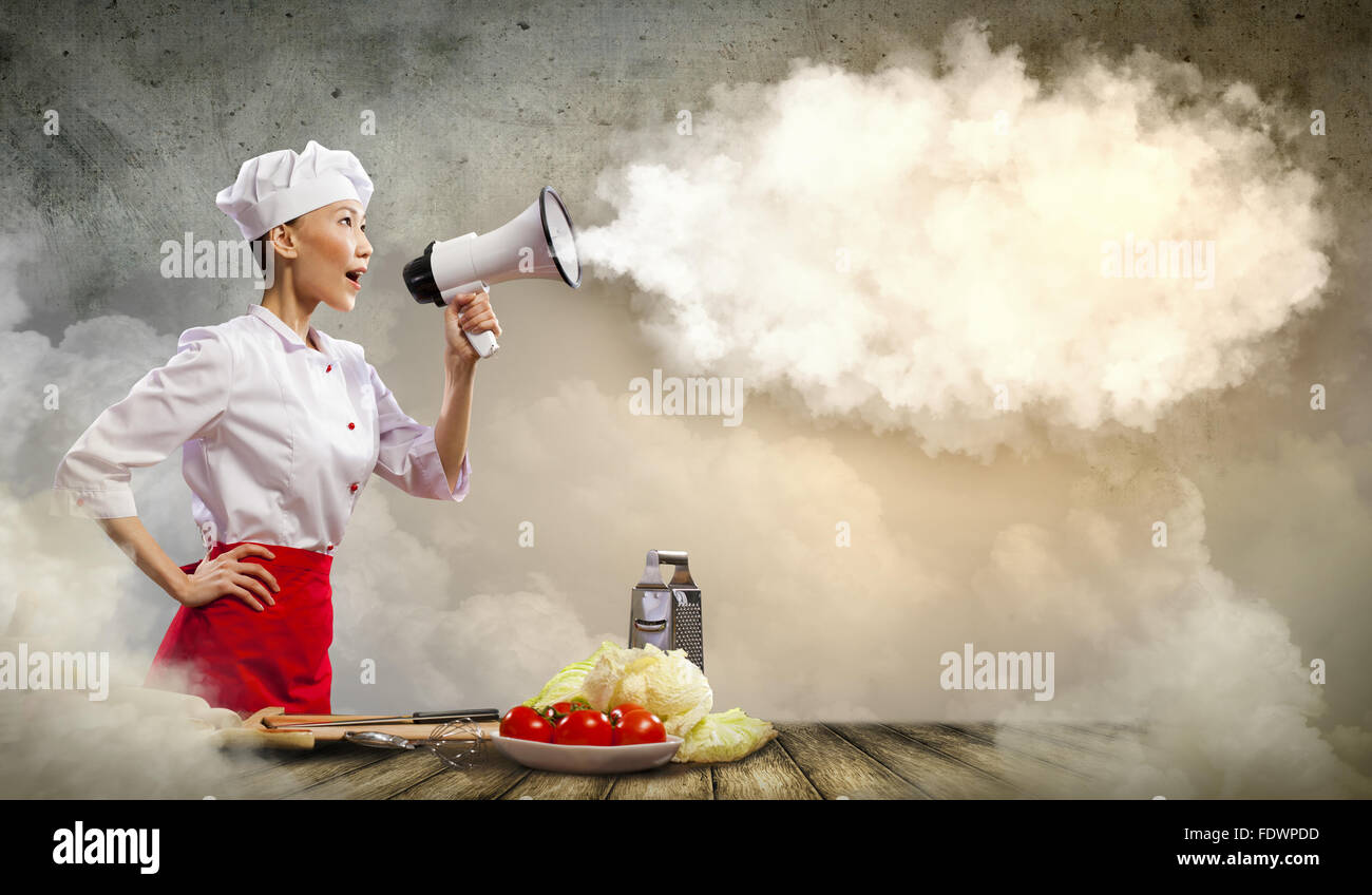 Asian female cook screaming loud in megaphone Stock Photo - Alamy