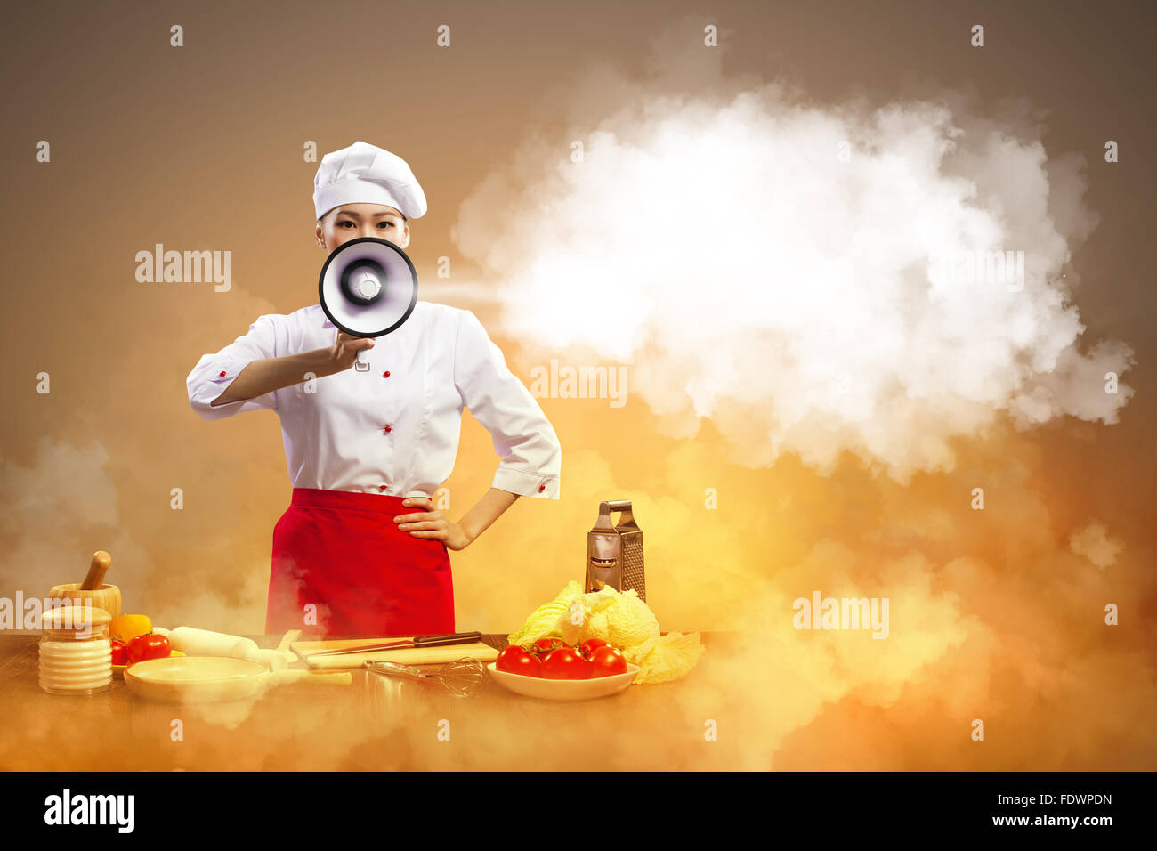 Asian female cook screaming loud in megaphone Stock Photo - Alamy