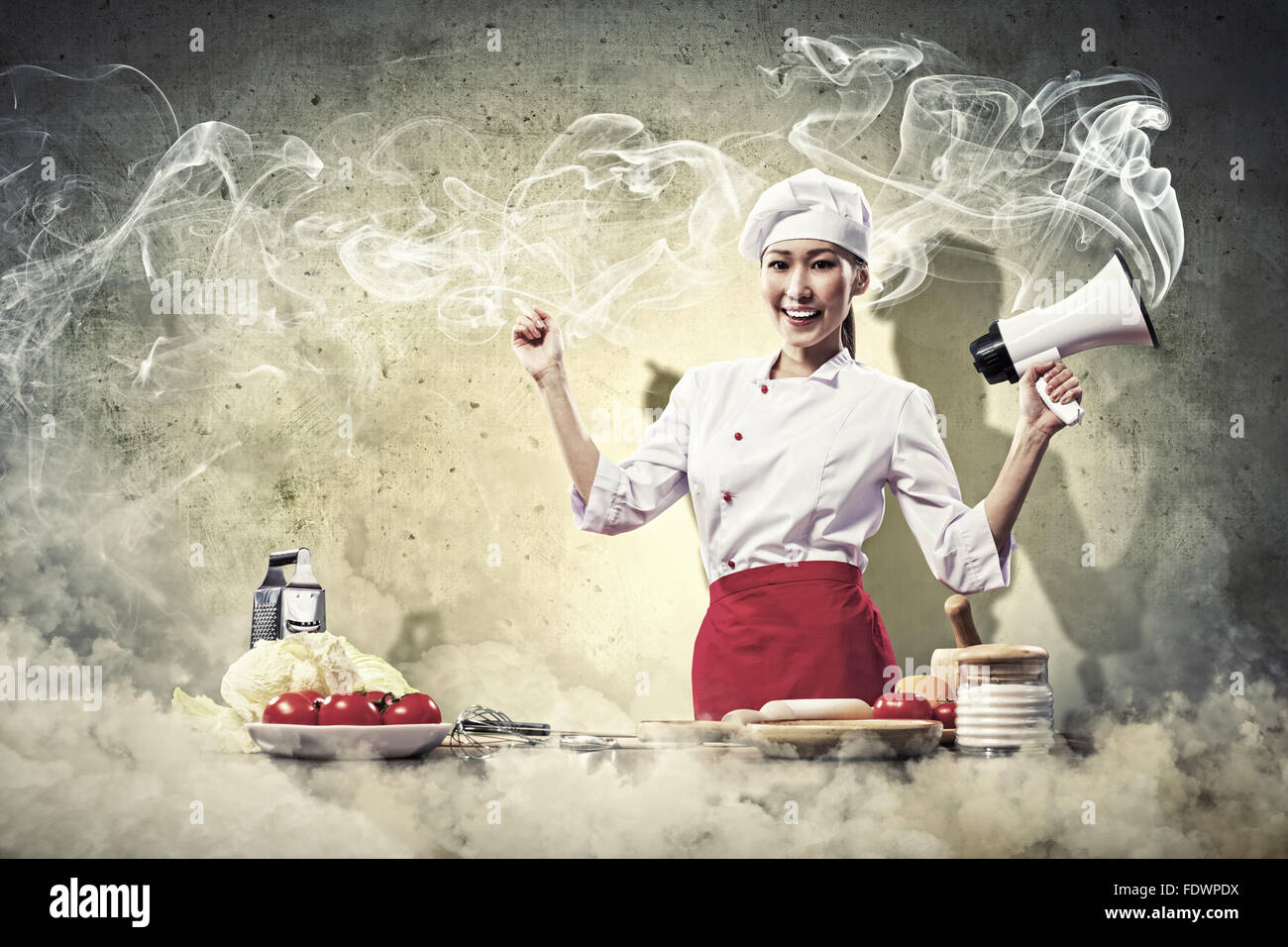 Asian female young cook smiling holding megaphone Stock Photo - Alamy
