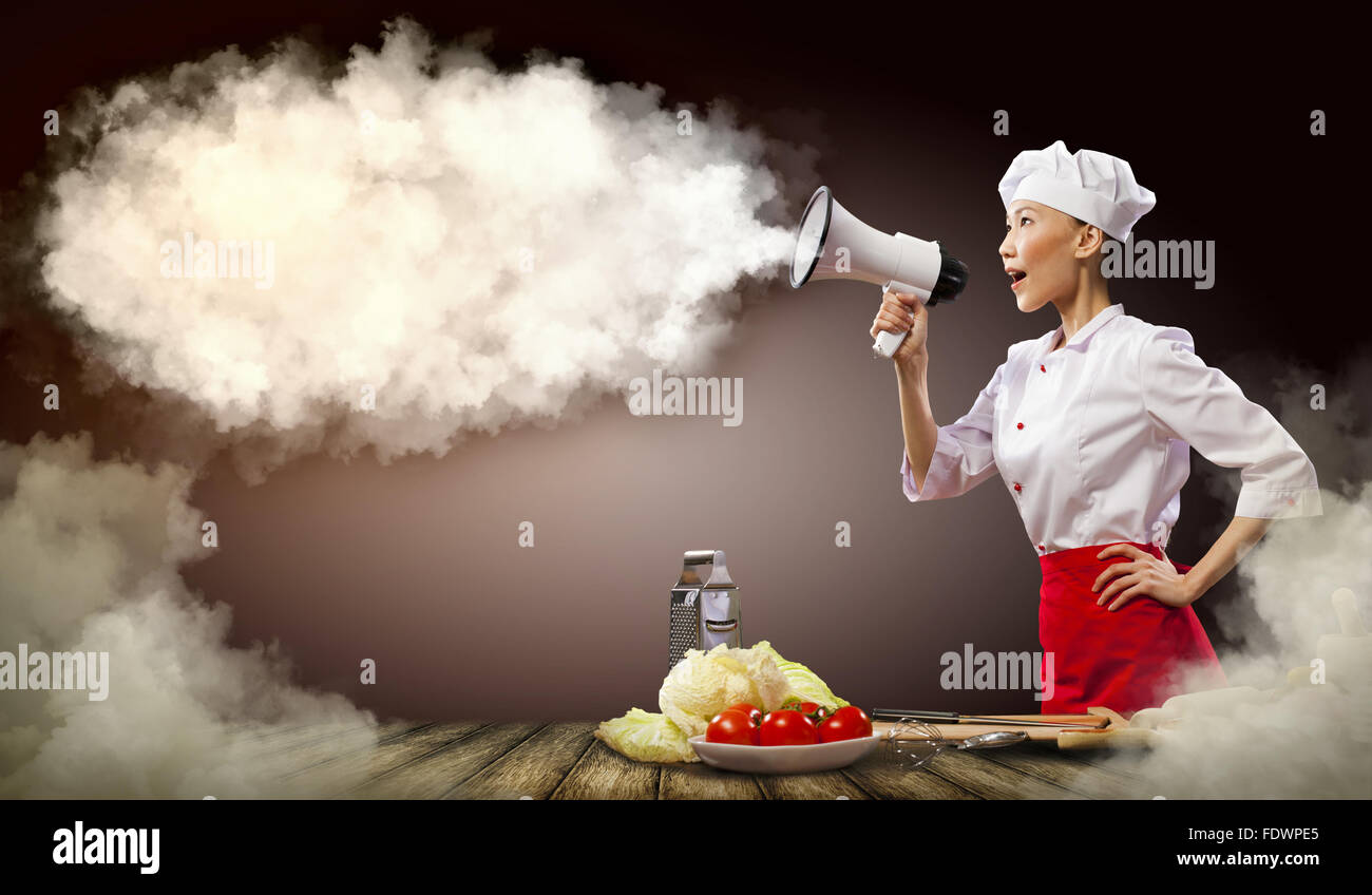 Asian female cook screaming loud in megaphone Stock Photo - Alamy