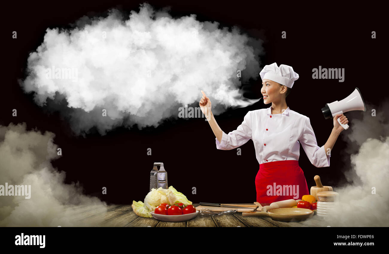 Asian female cook holding megaphone with space for text Stock Photo - Alamy