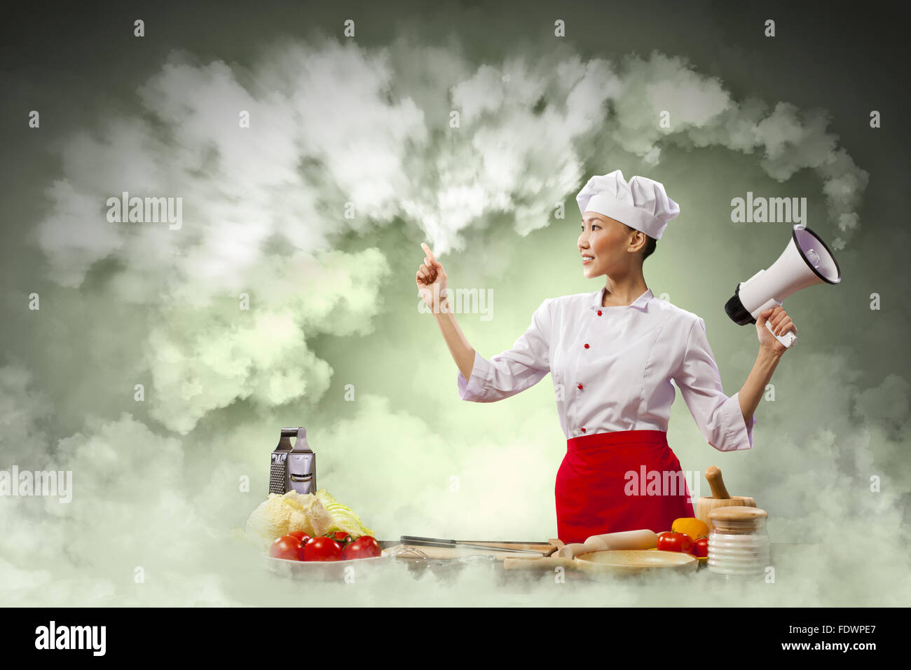 Asian female young cook smiling holding megaphone Stock Photo - Alamy