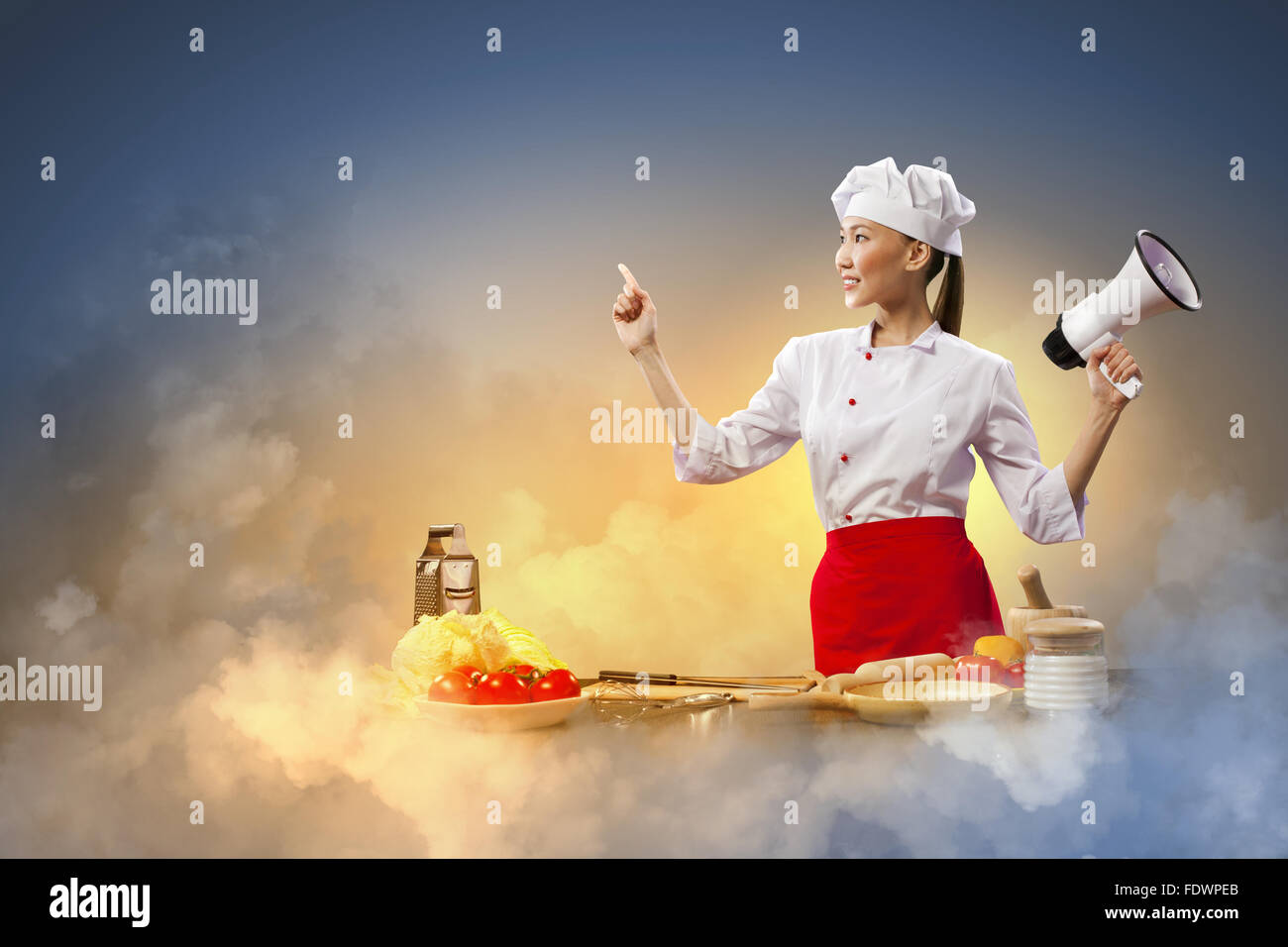 Asian female young cook smiling holding megaphone Stock Photo - Alamy