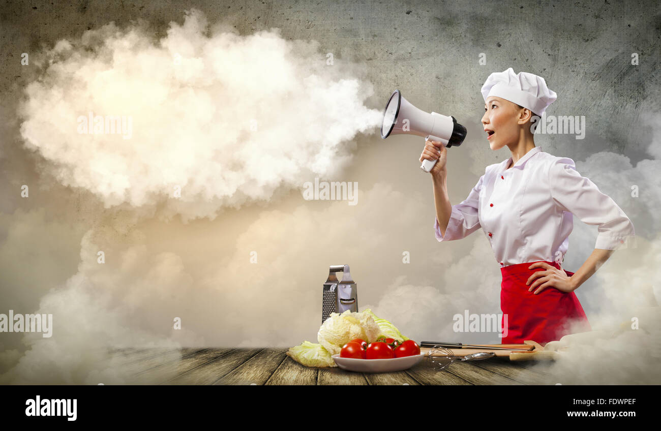 Asian female cook screaming loud in megaphone Stock Photo - Alamy