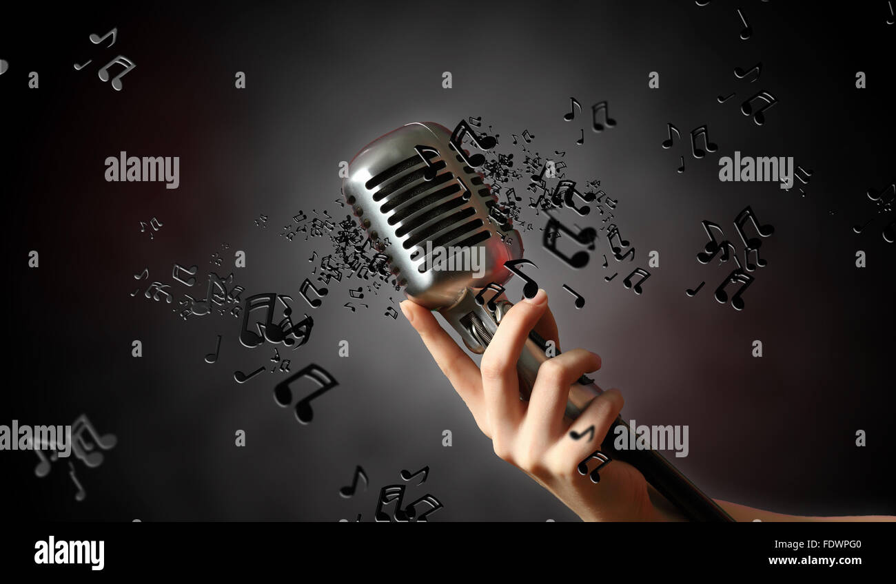 Single retro microphone against dark background with music notes Stock ...