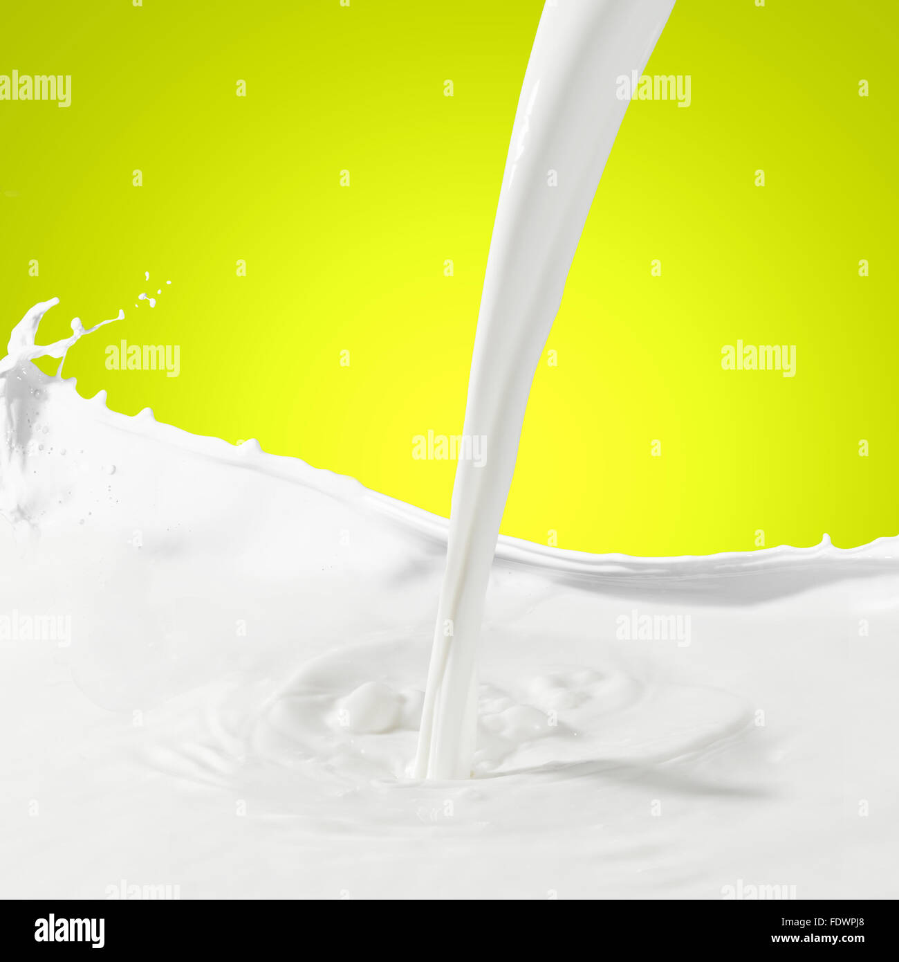 Pouring white milk splash on colour background Stock Photo - Alamy