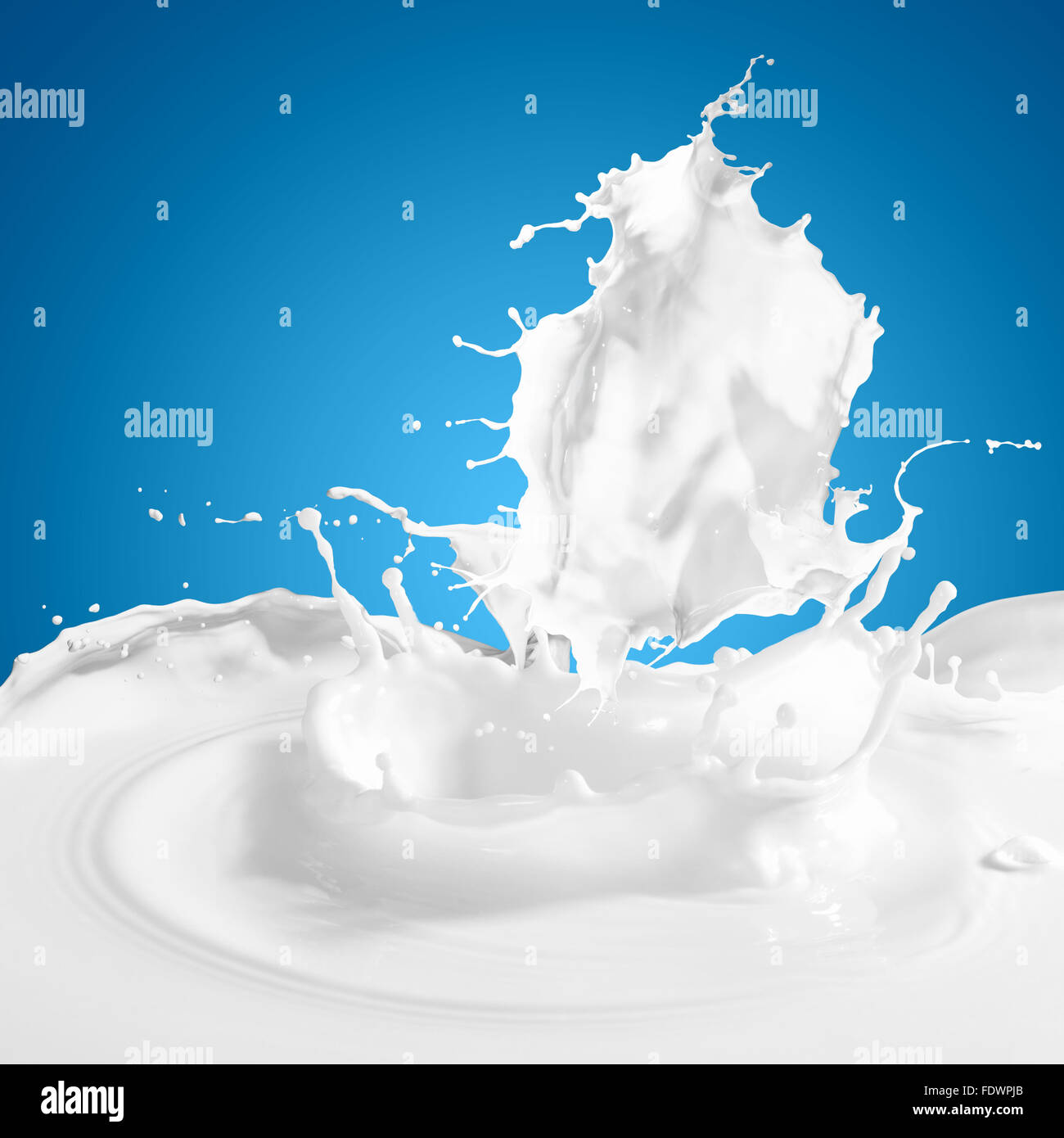 Pouring white milk splash on colour background Stock Photo - Alamy