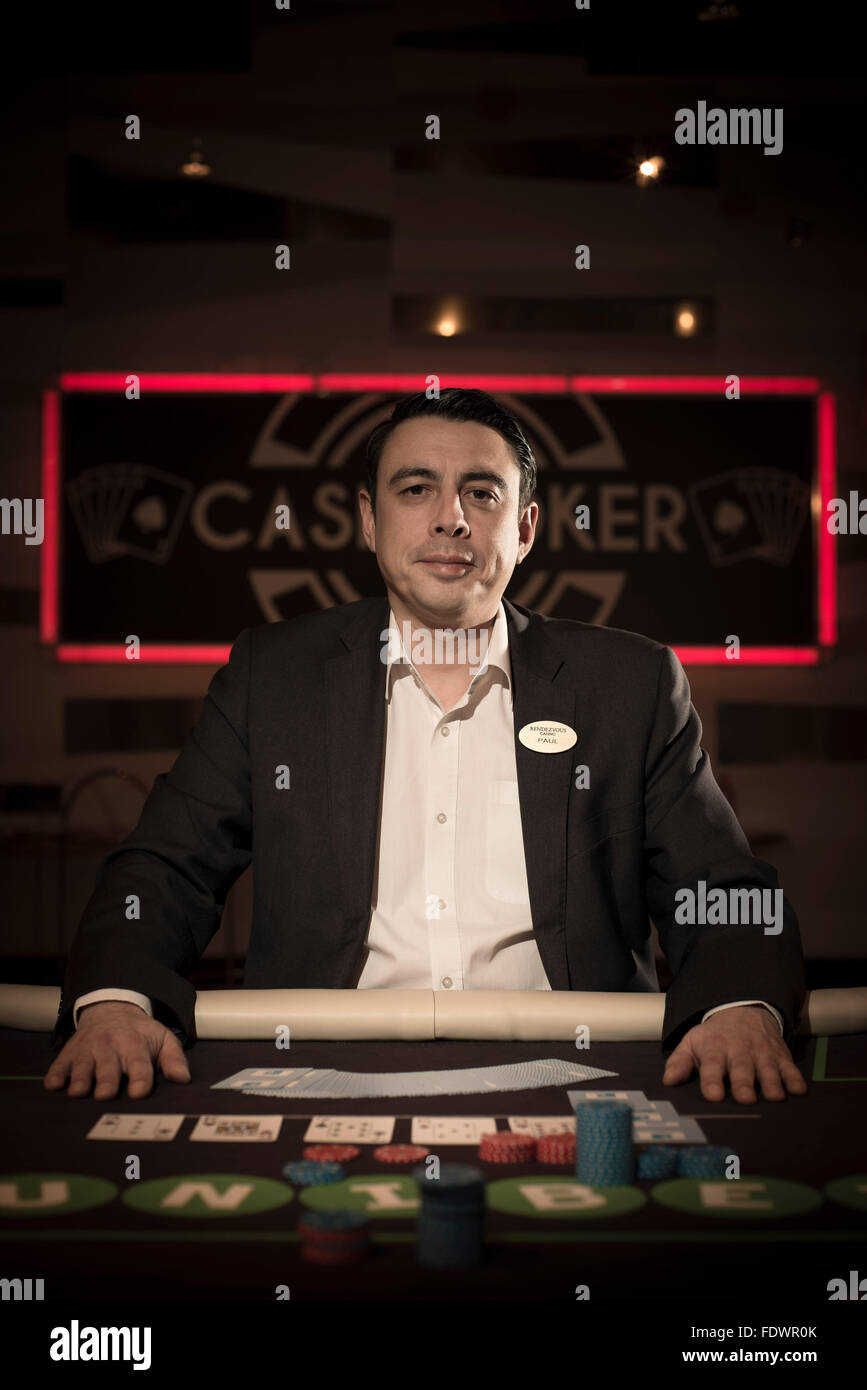 a croupier poses for the camera at a casino ready for people to start ...