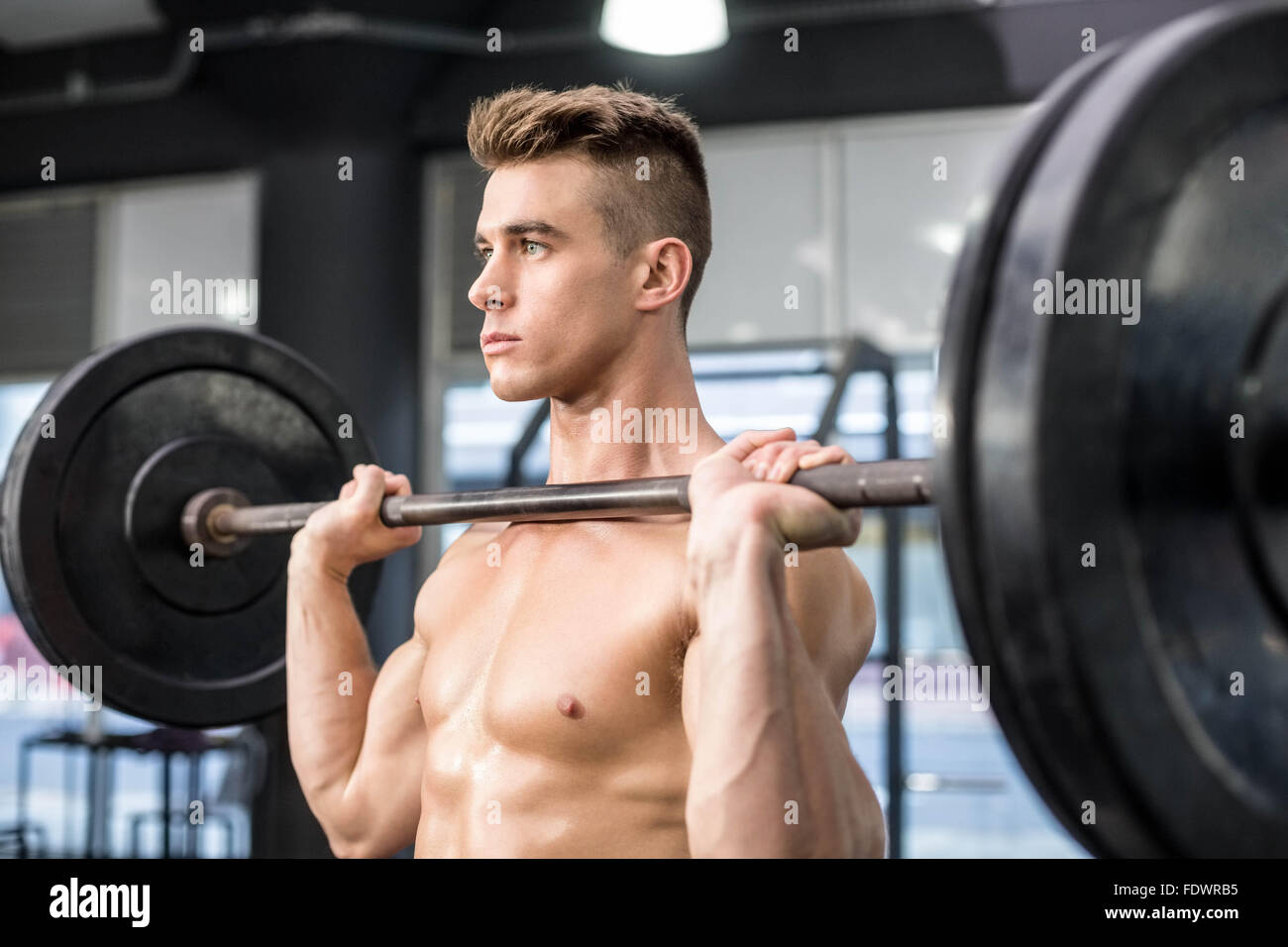 Fit man lifting barbell Stock Photo - Alamy