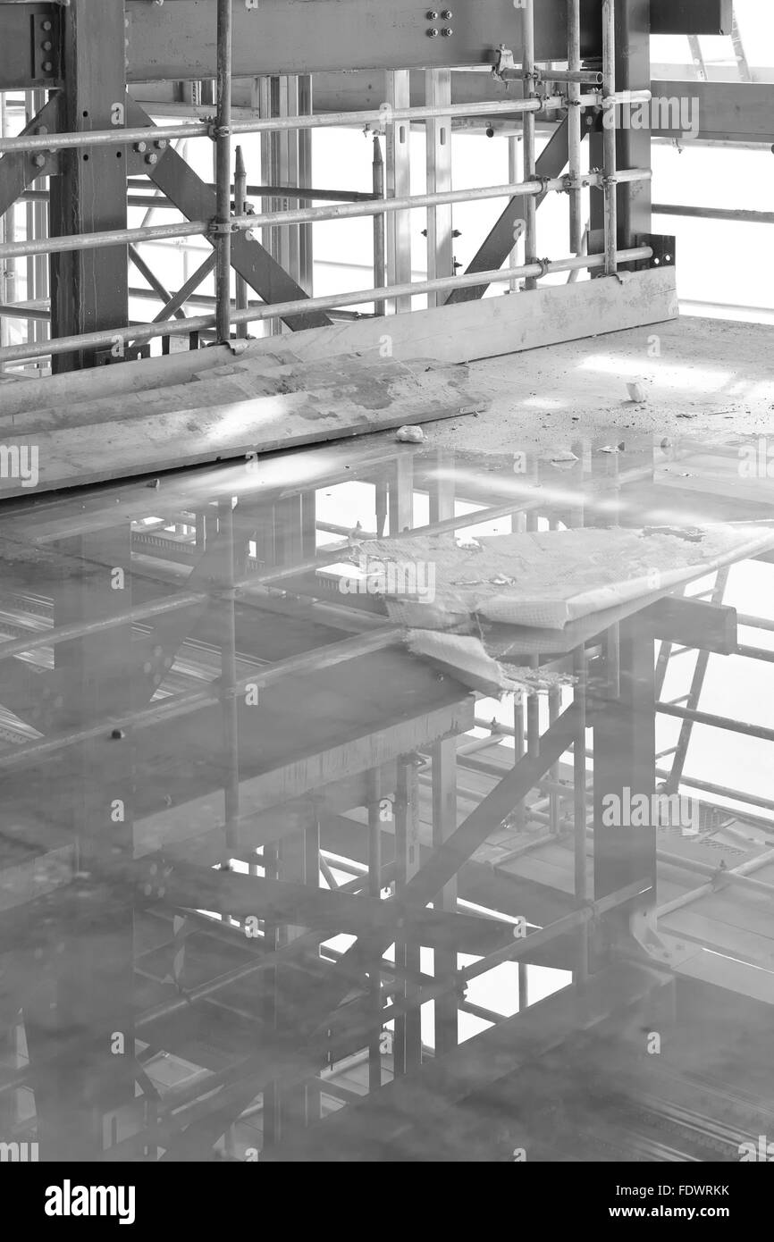 A construction site with concrete slab with water puddle and ...