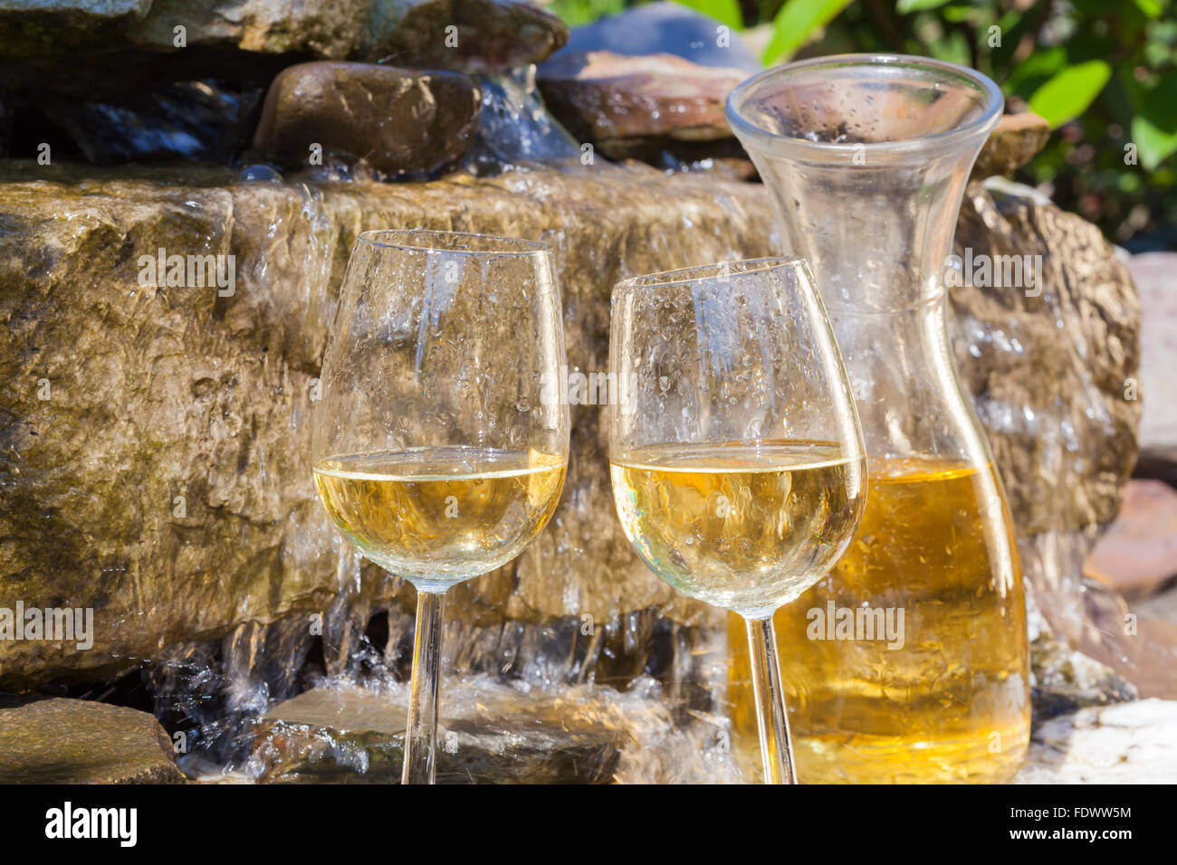 wine cooled in waterfall during hiking break Stock Photo - Alamy