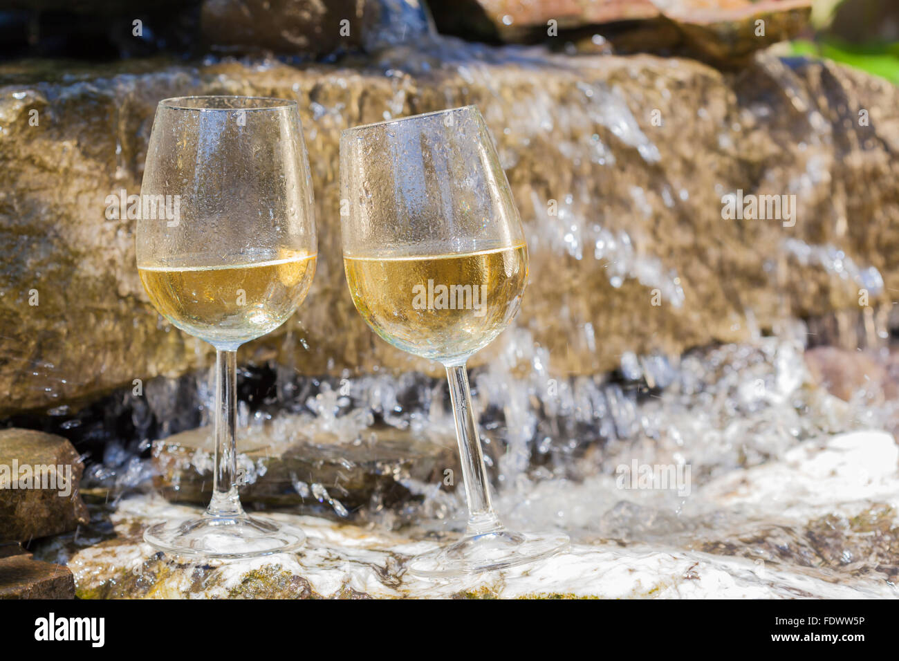 wine cooled in waterfall during hiking break Stock Photo - Alamy