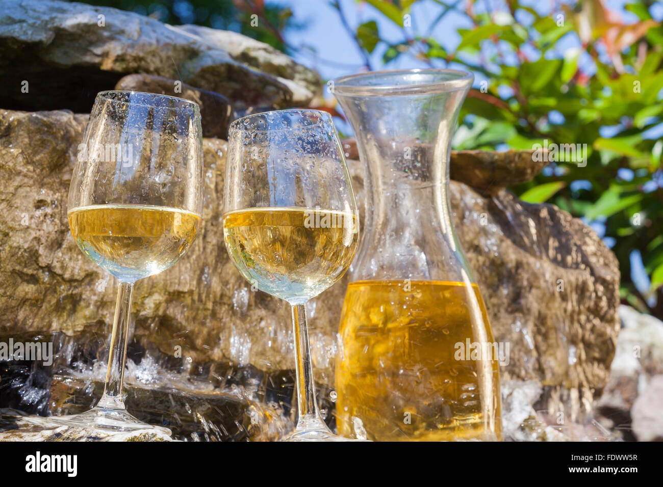 wine cooled in waterfall during hiking break Stock Photo - Alamy